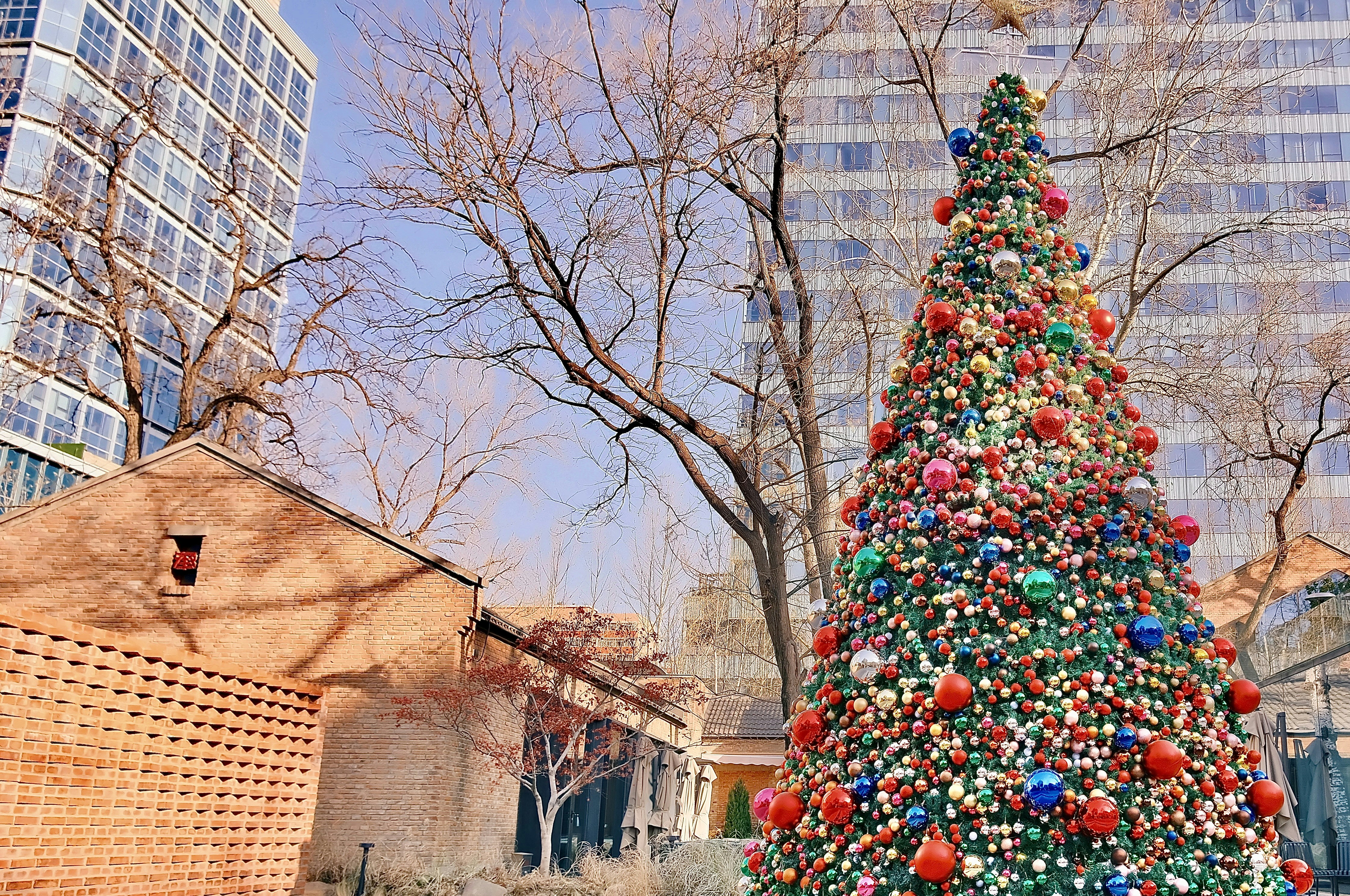 A large christmas tree in front of a tall building photo – Free Beijing ...