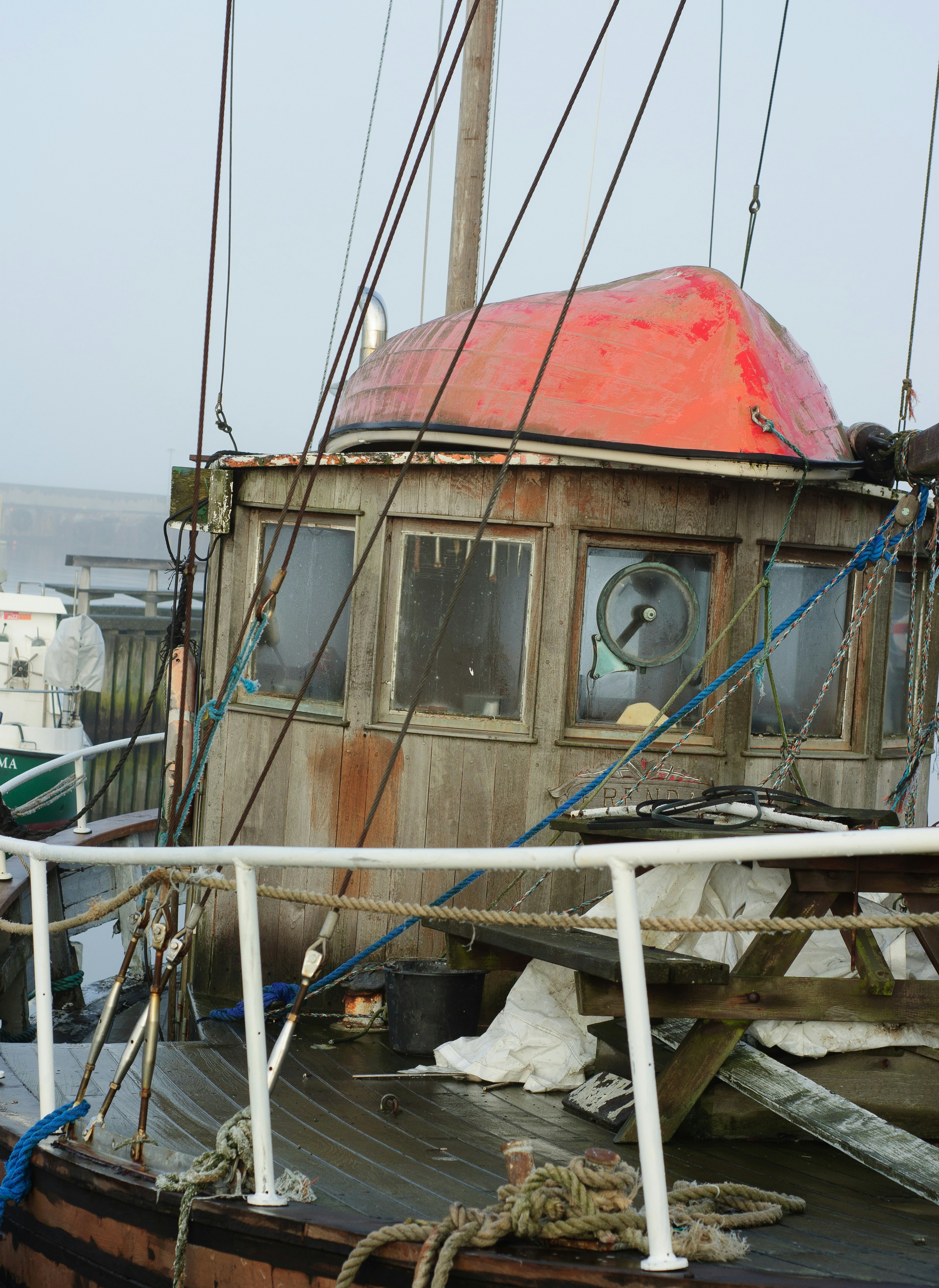 Red Hood on the Rusted Harbor Vessel: A Quiet Portrait