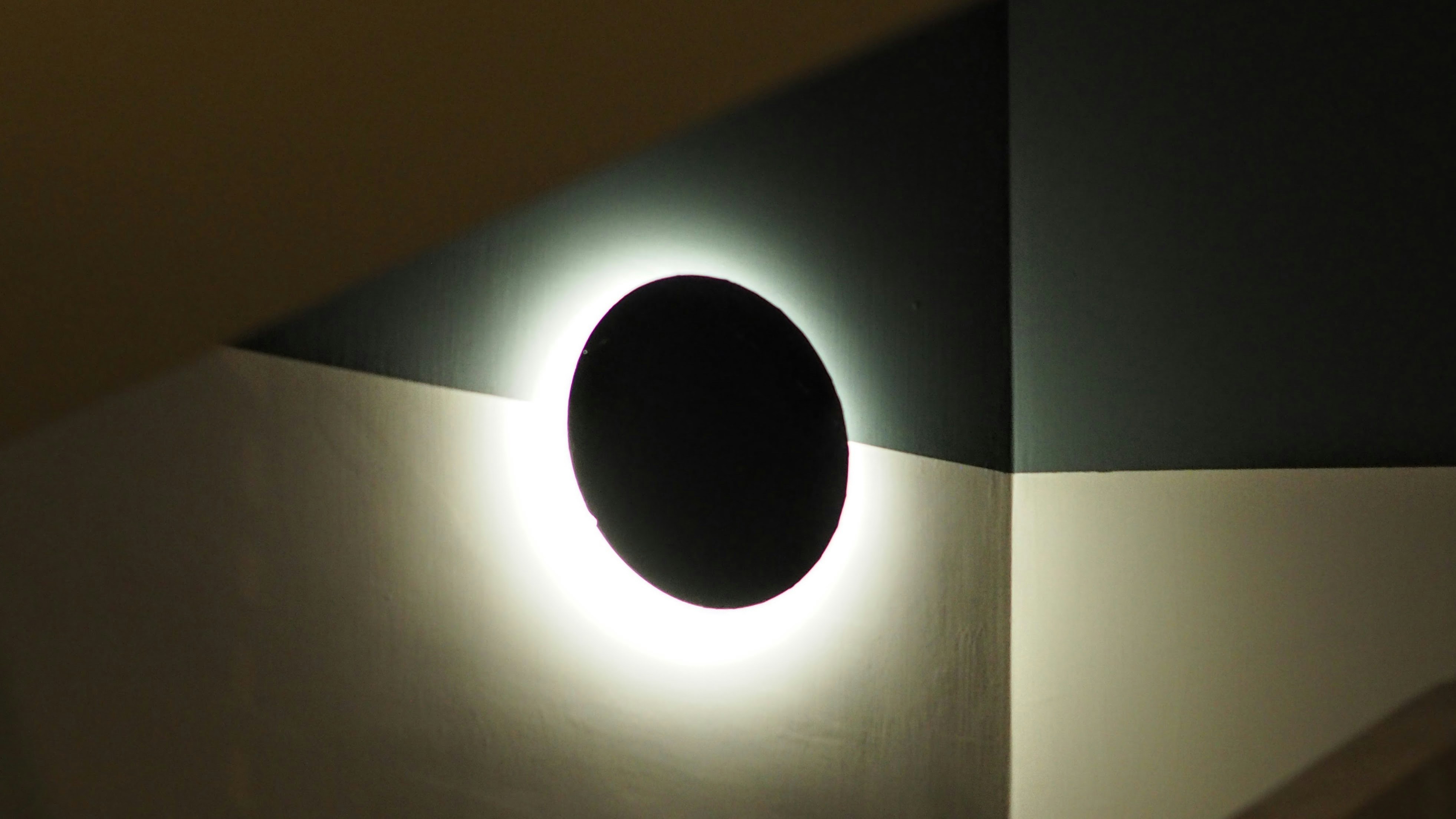 Halo on a Corner: A Backlit Circle Against a Two-Tone Wall