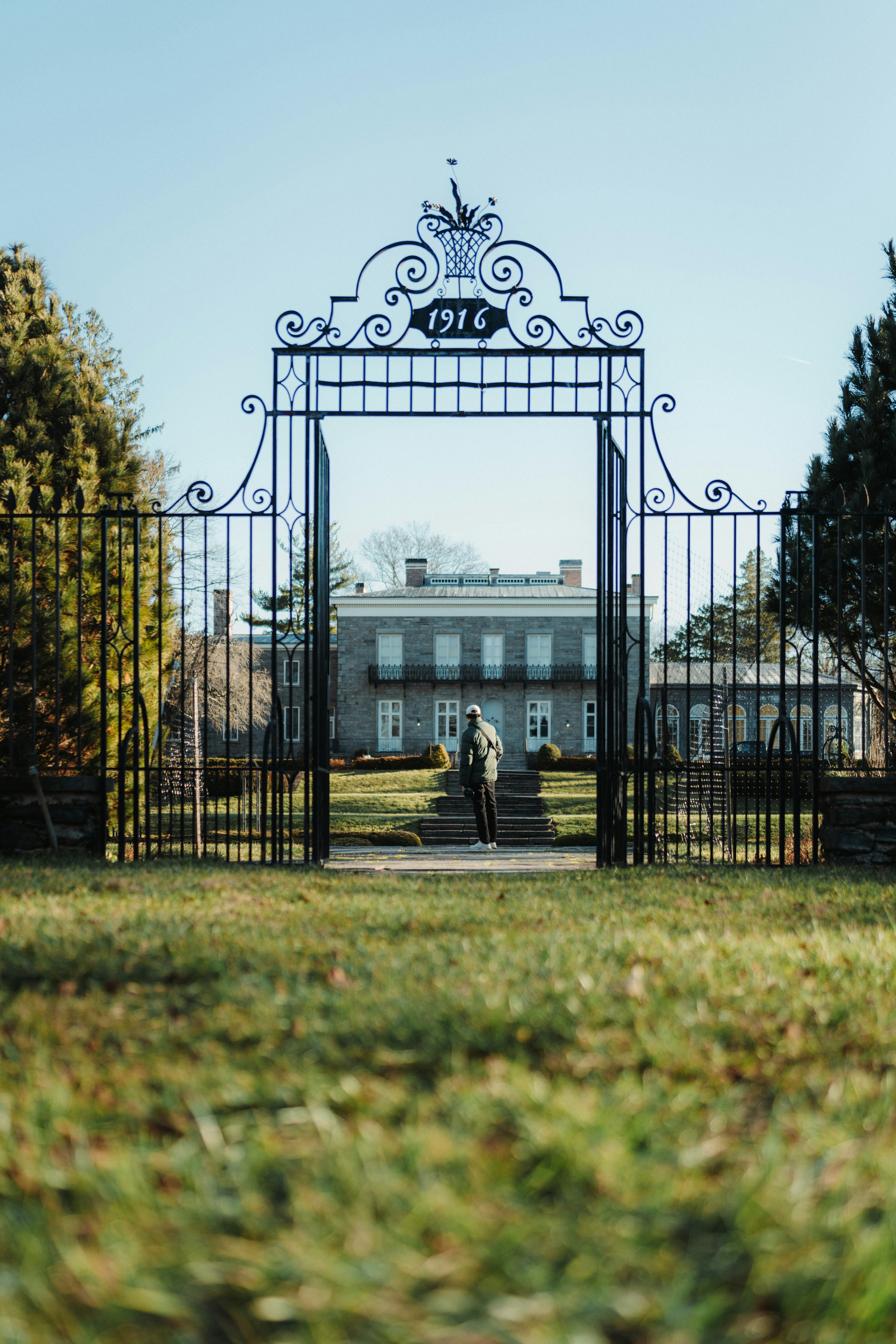 Two people standing in front of a gate photo – Free Person Image on ...