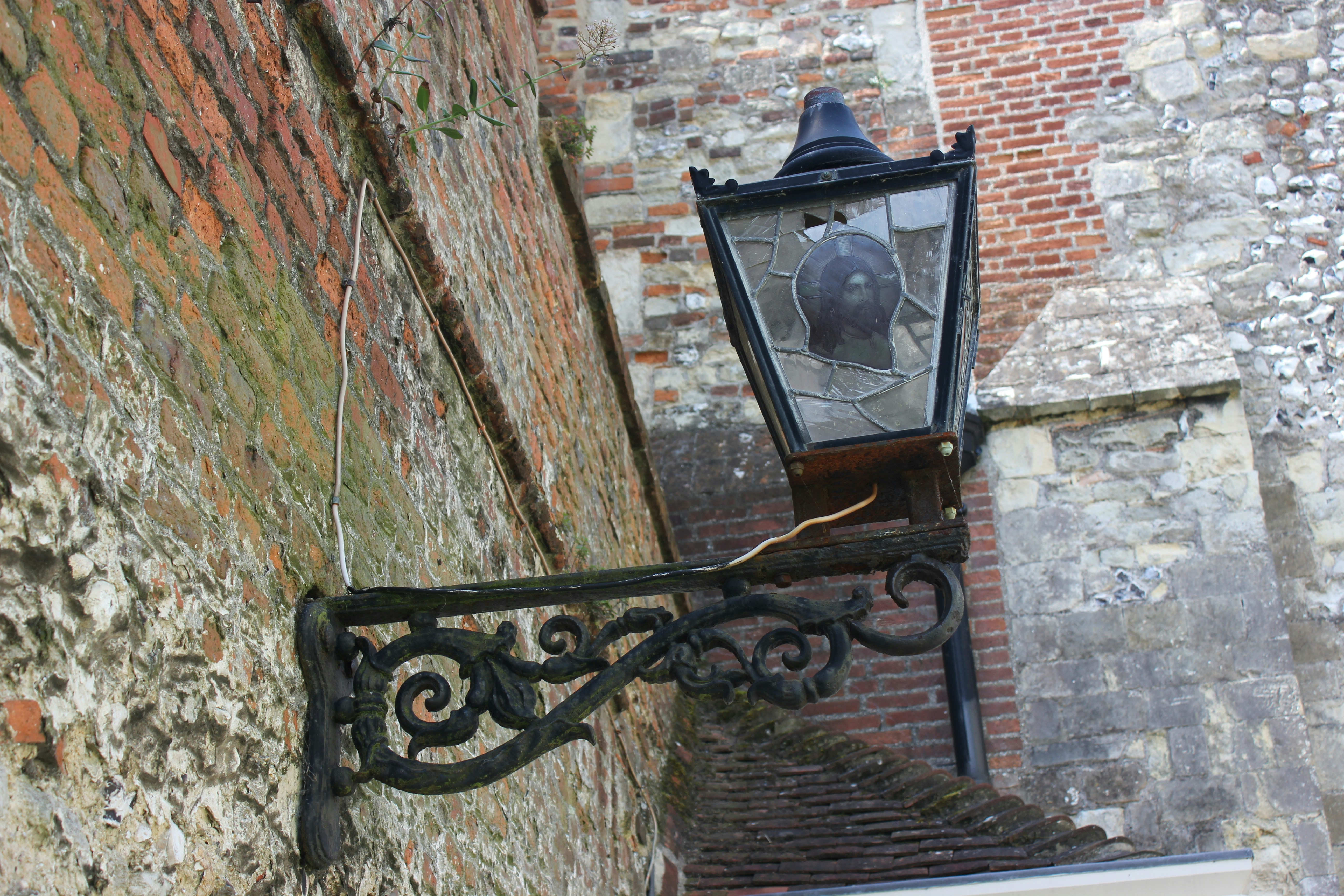 Heritage Lantern Casting Shadow on Weathered Brick Wall