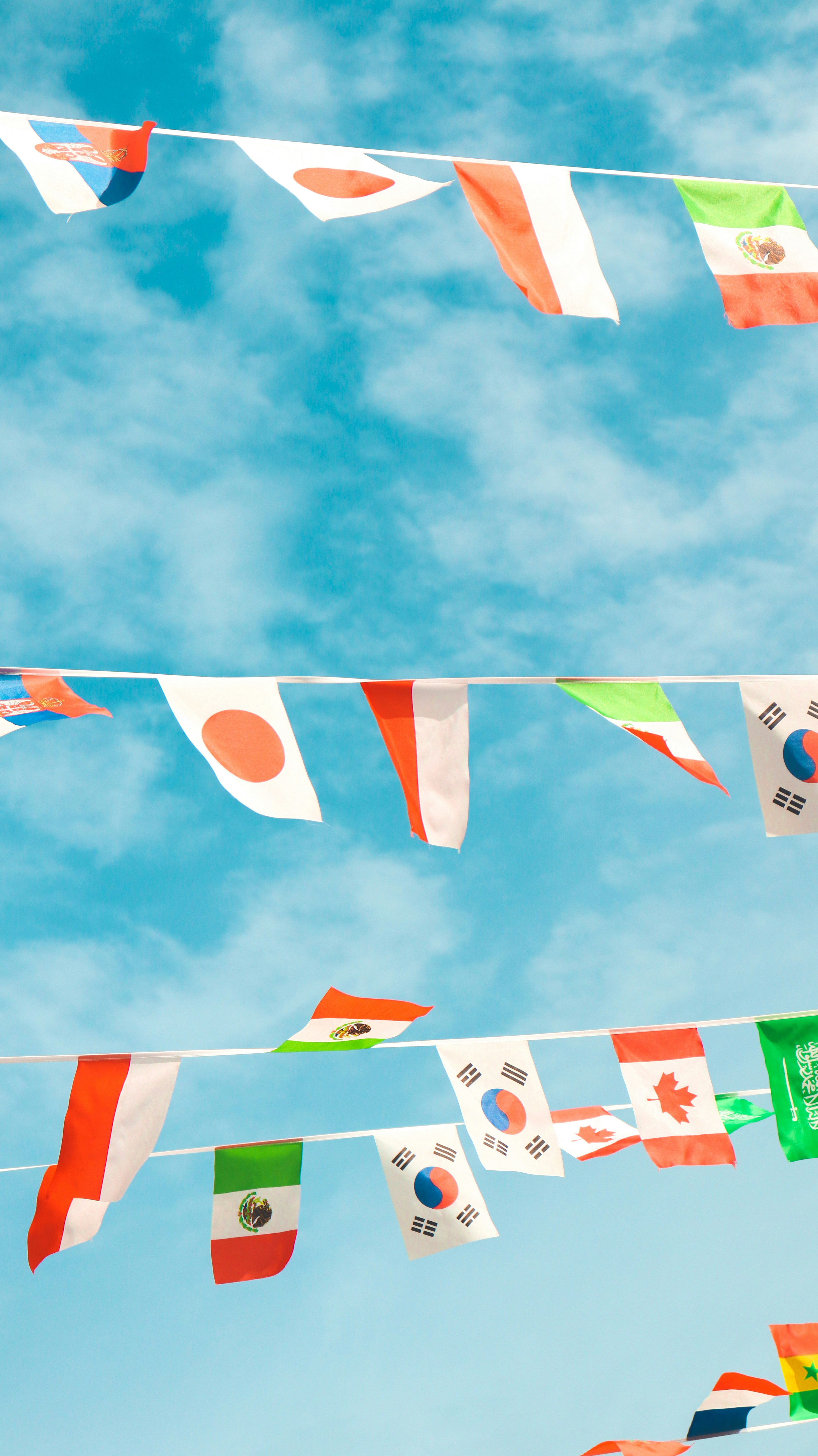 A bunch of flags that are flying in the air photo – Free Flag Image on ...