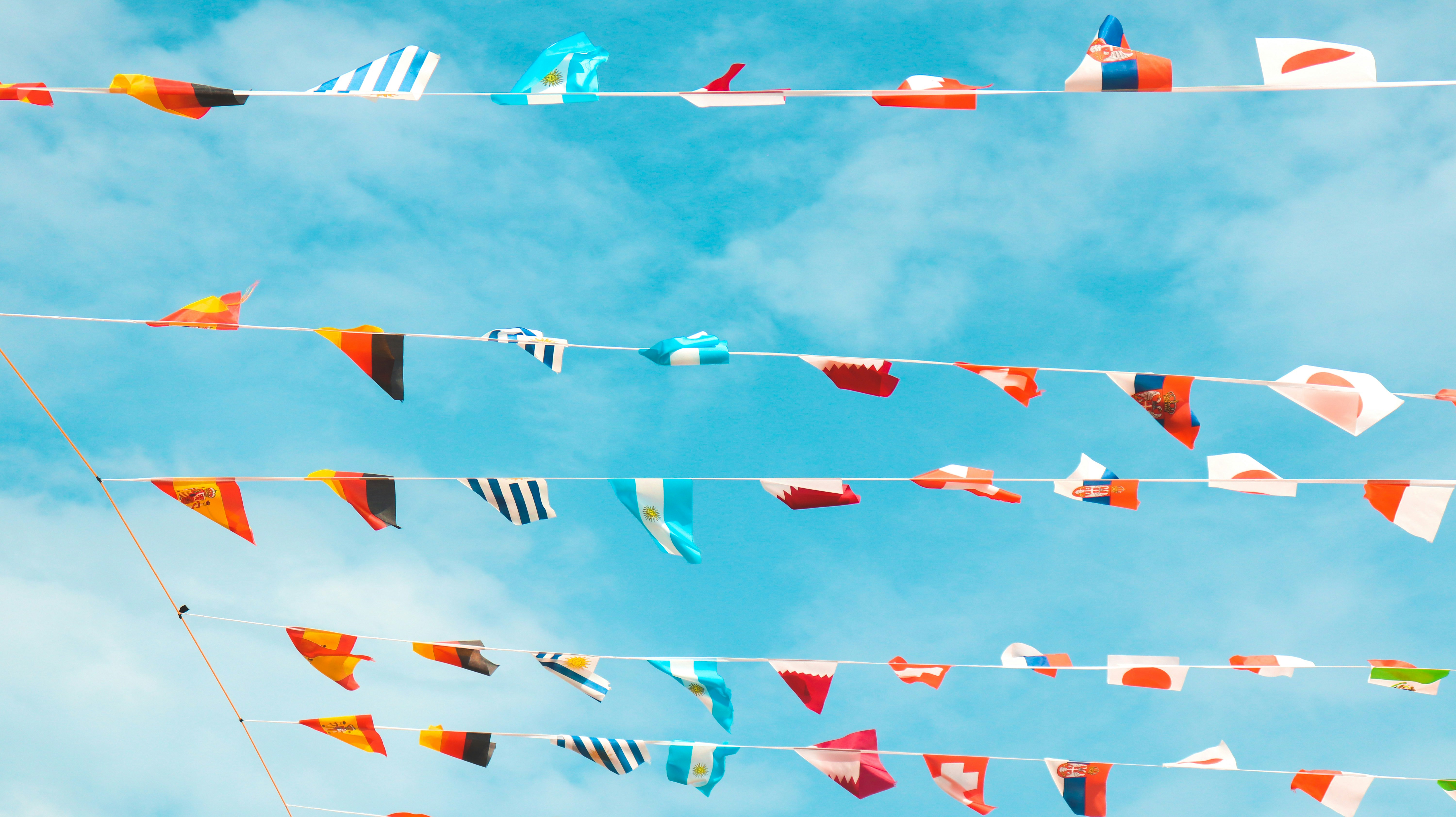 A bunch of flags that are hanging in the air photo – Free Nature Image ...