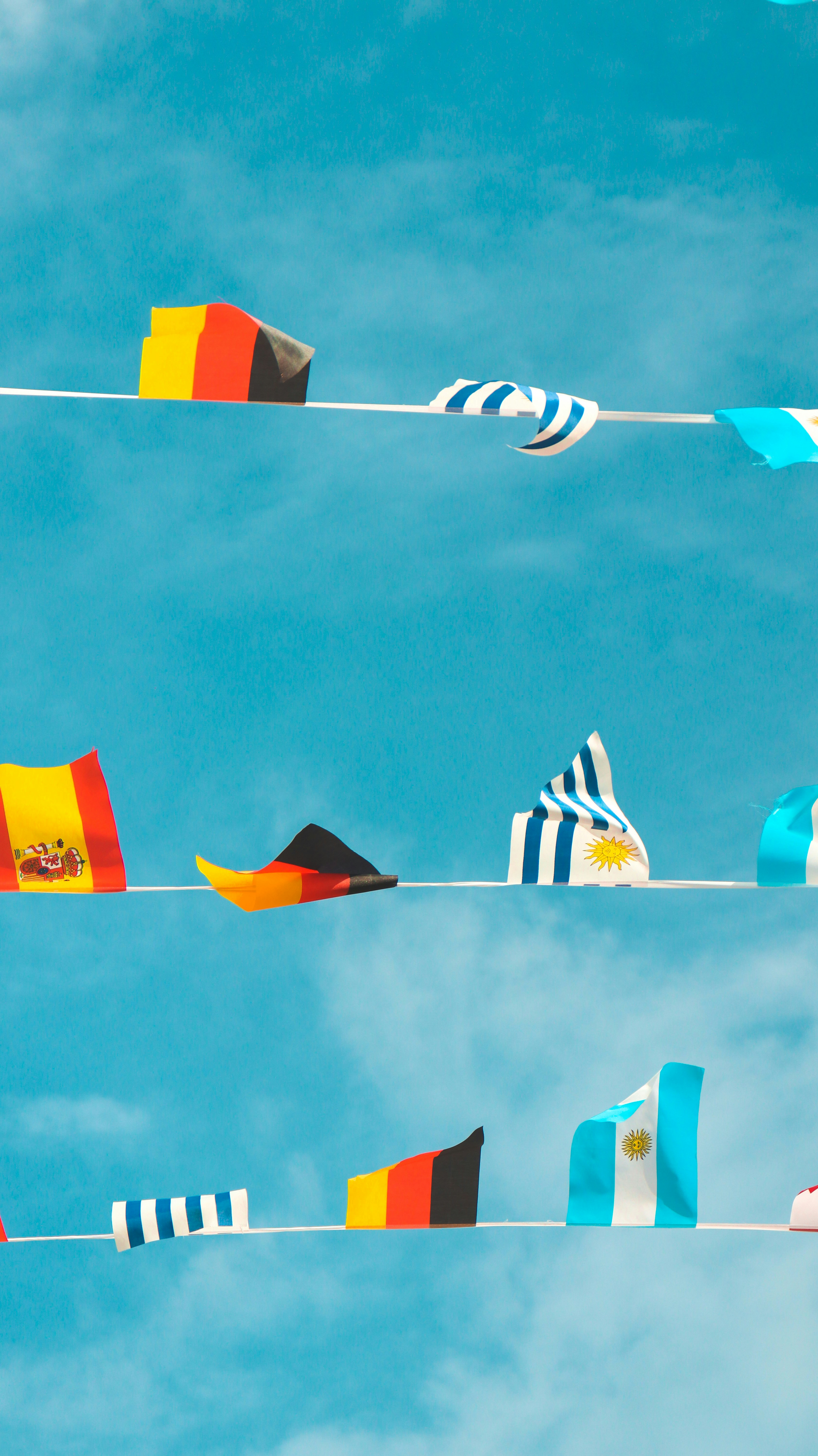 A bunch of flags that are flying in the sky photo – Free Flag Image on ...