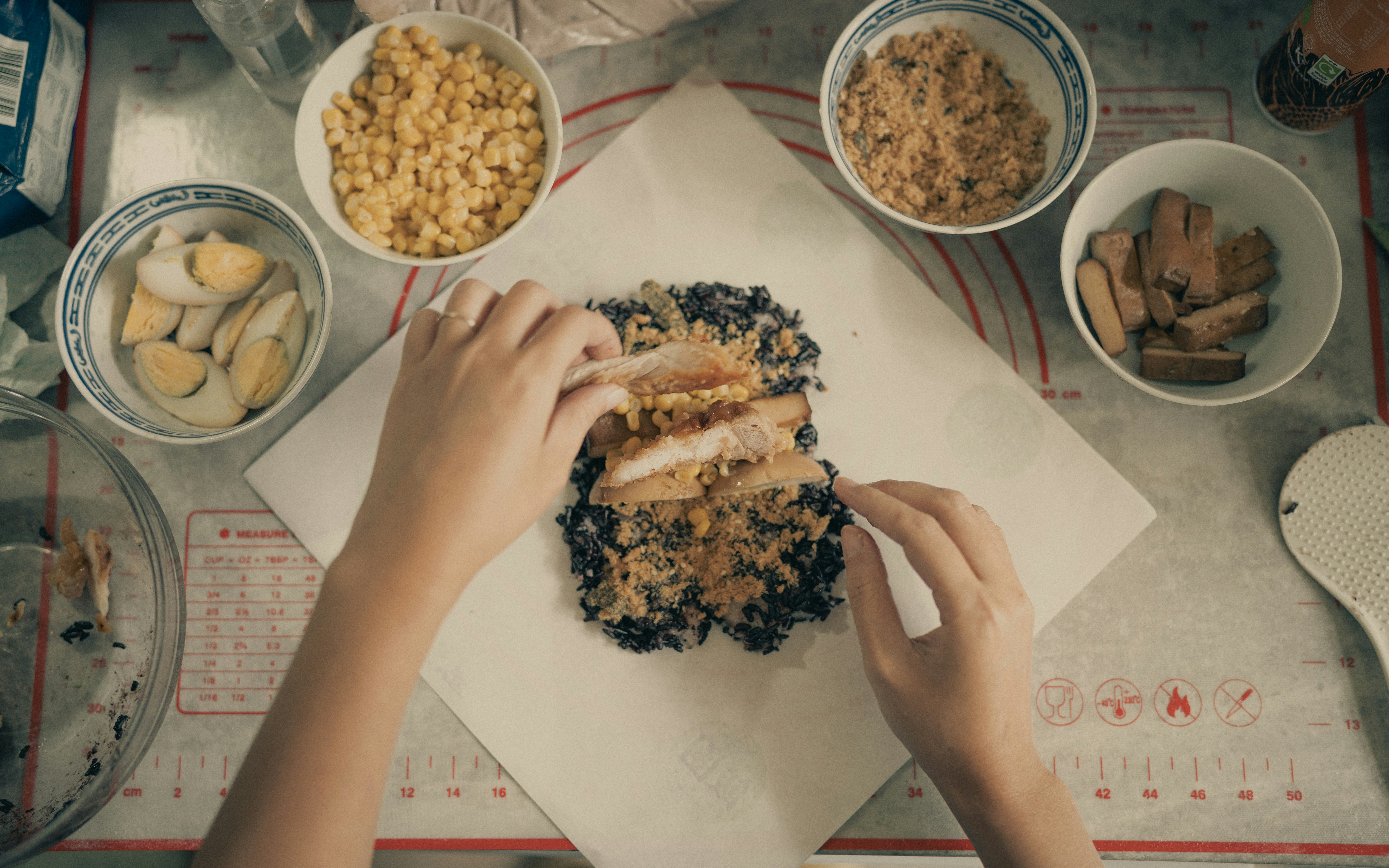 A person cutting up food on top of a cutting board photo – Free Food ...