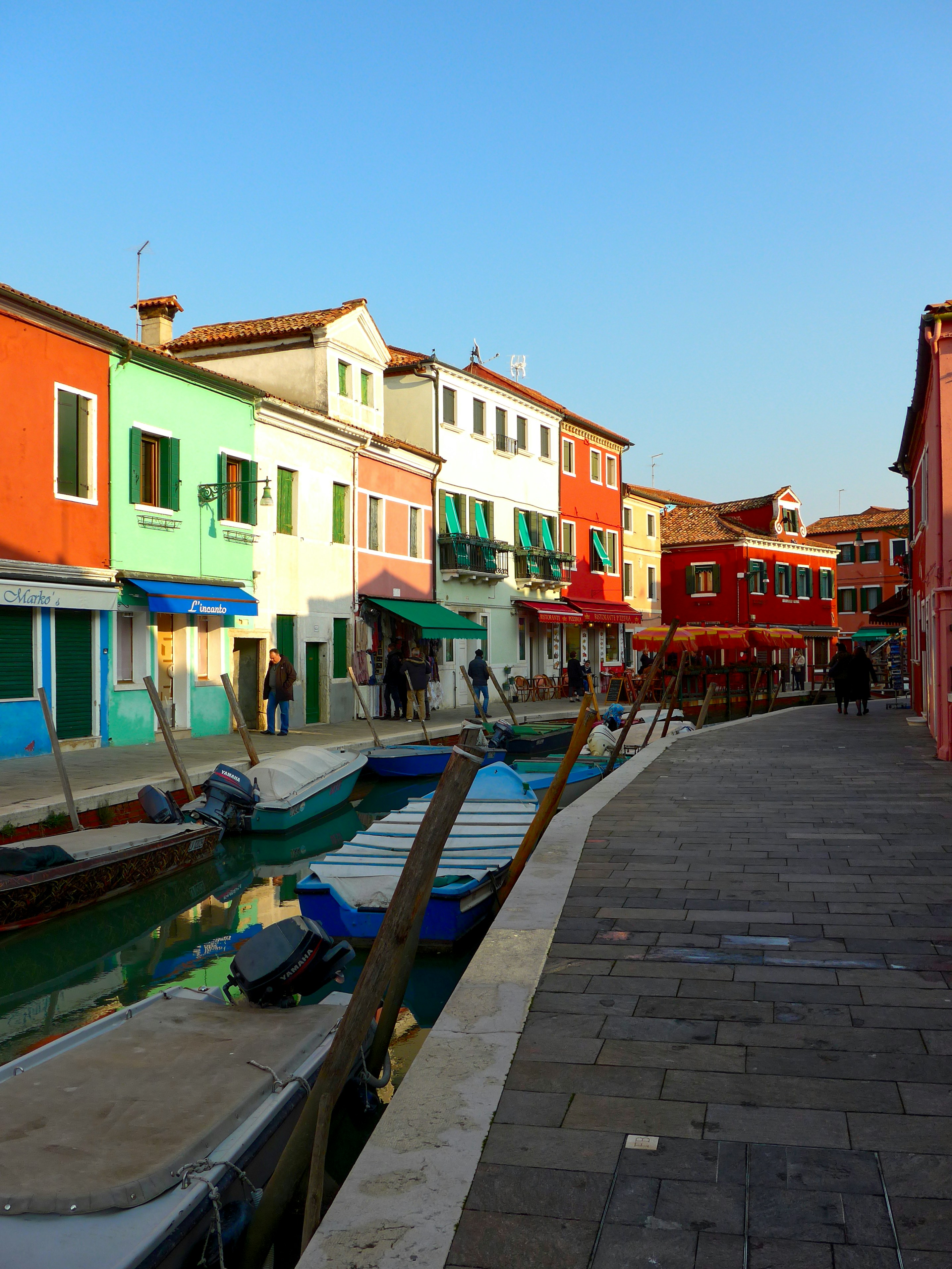 A row of houses next to a body of water photo – Free Italy Image on ...