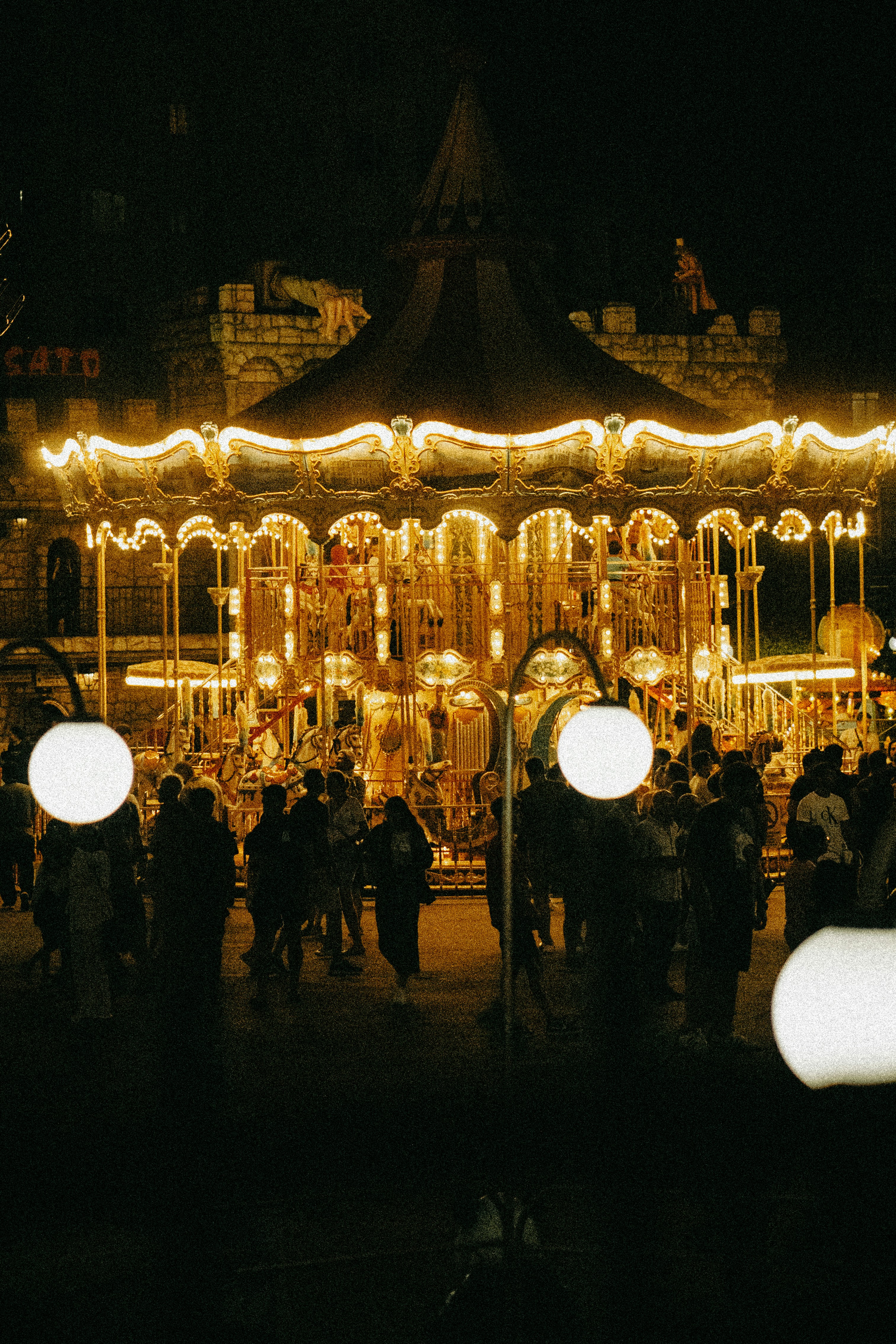 A group of people standing around a merry go round photo – Free Fun ...