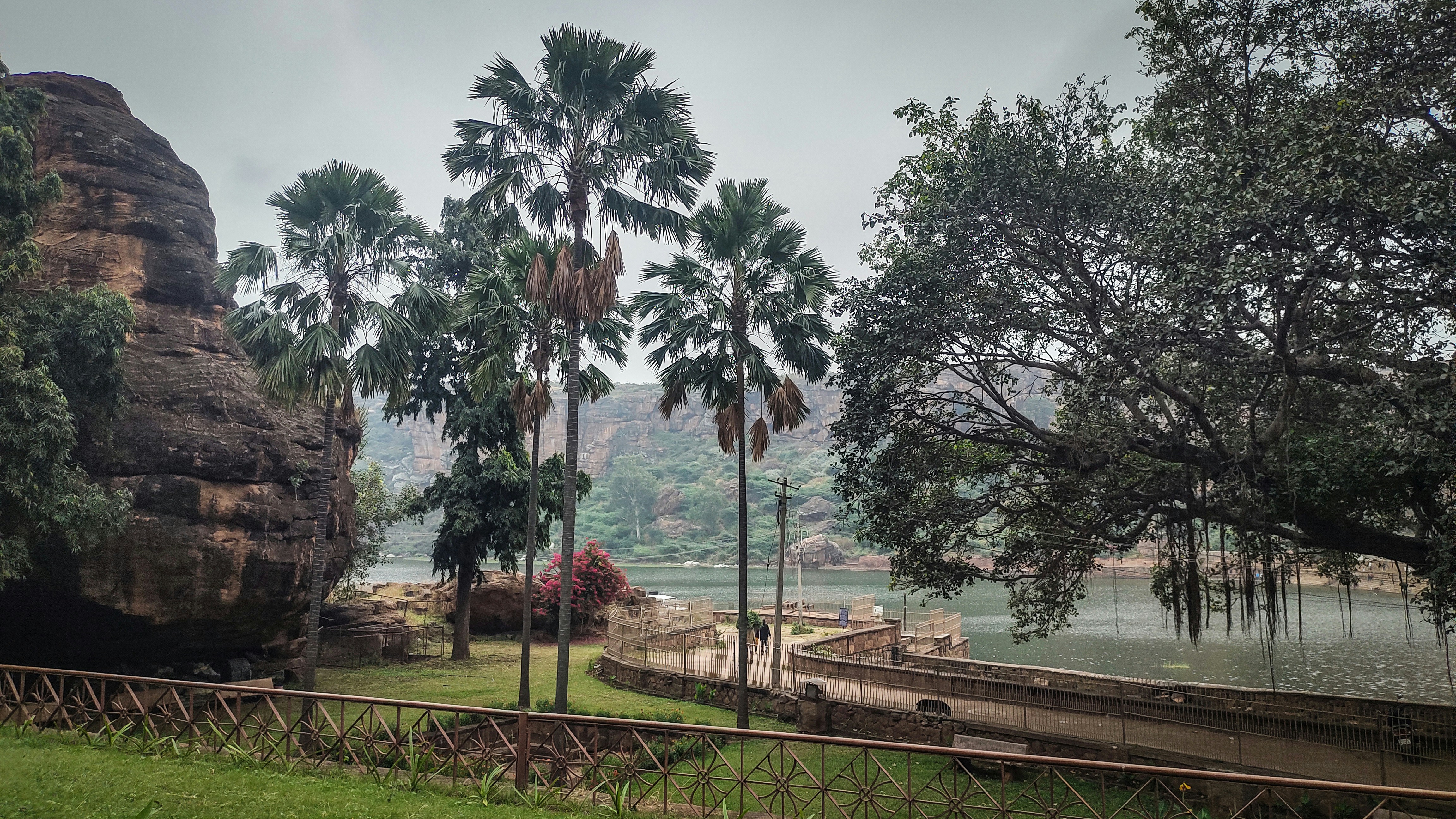 A view of a body of water surrounded by palm trees photo – Free Badami ...