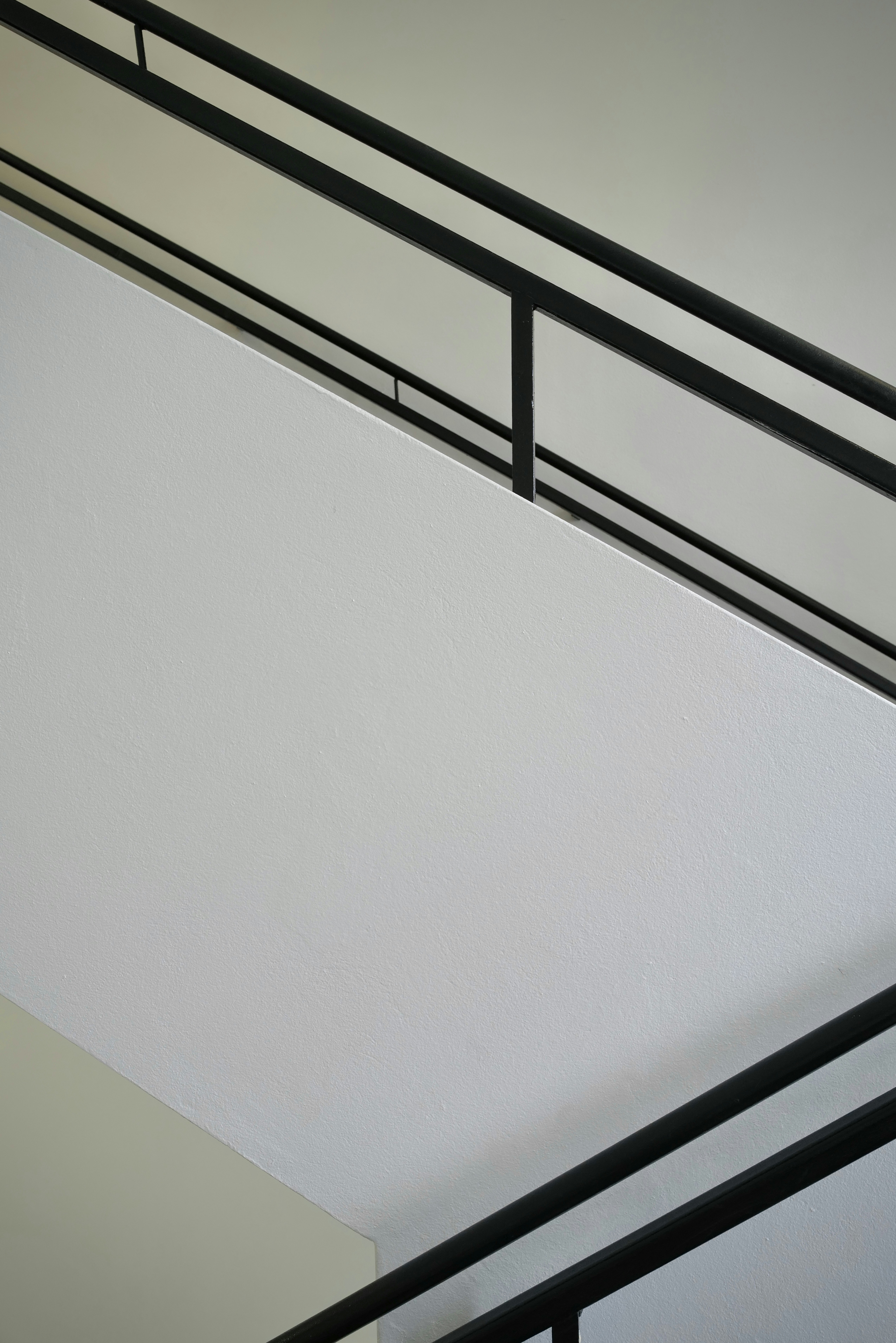 A close up of a metal hand rail on a wall photo – Free Handrail Image ...