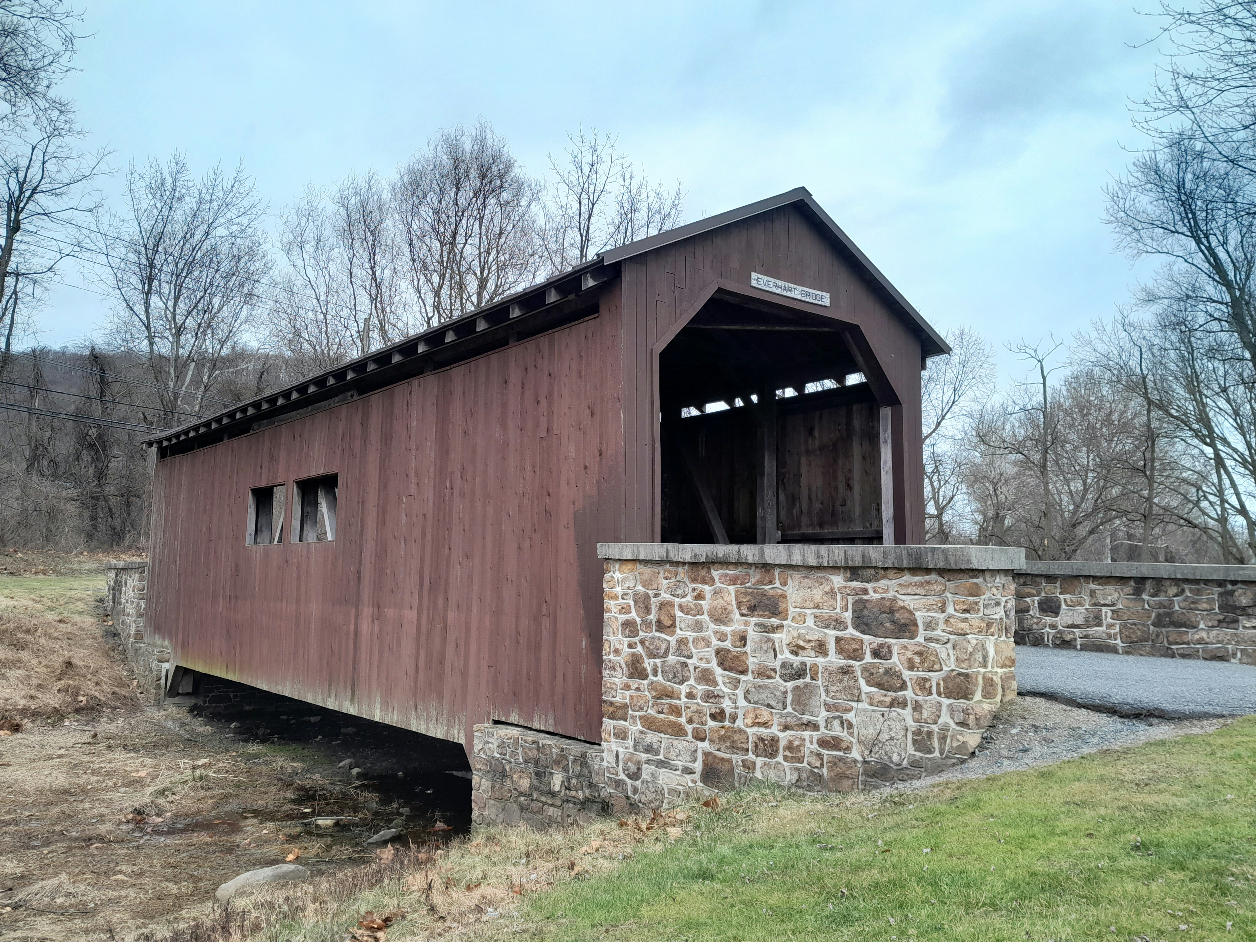 The Red Covered Bridge Over a Quiet Channel