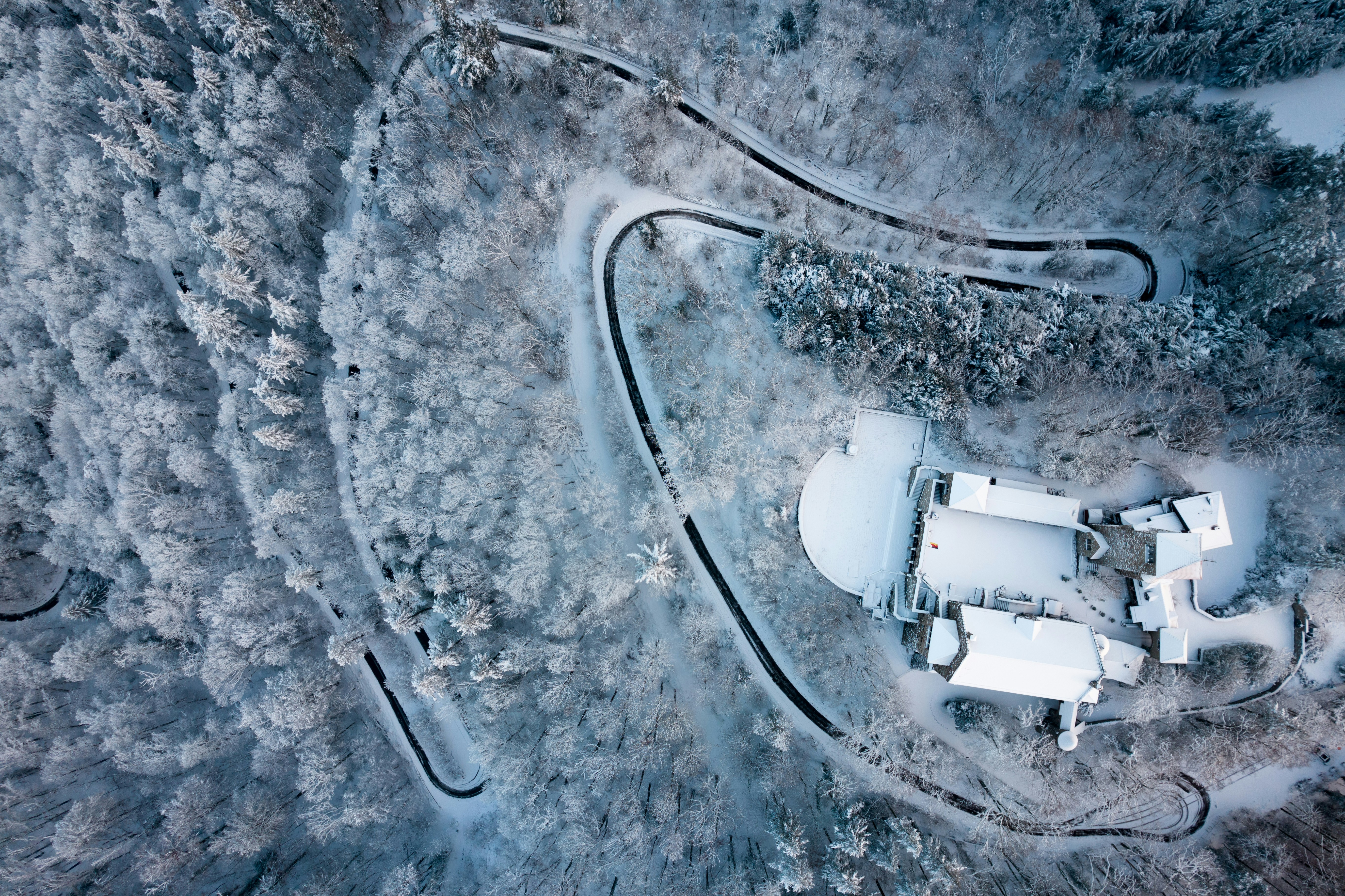 Snowbound Observatory: Aerial View of the Dome and Turrets in a Frosted Clearing