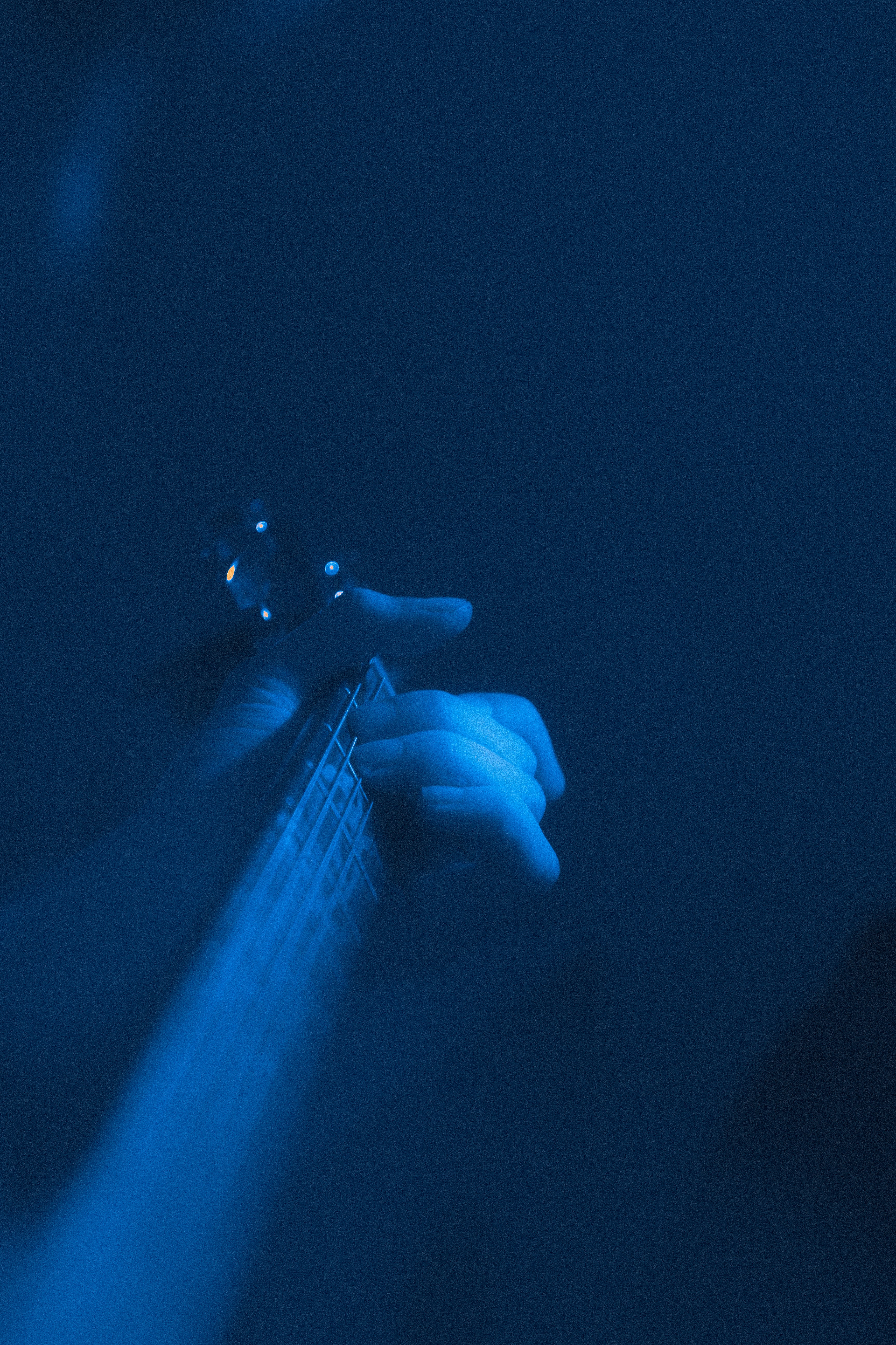 a person playing a guitar in the dark