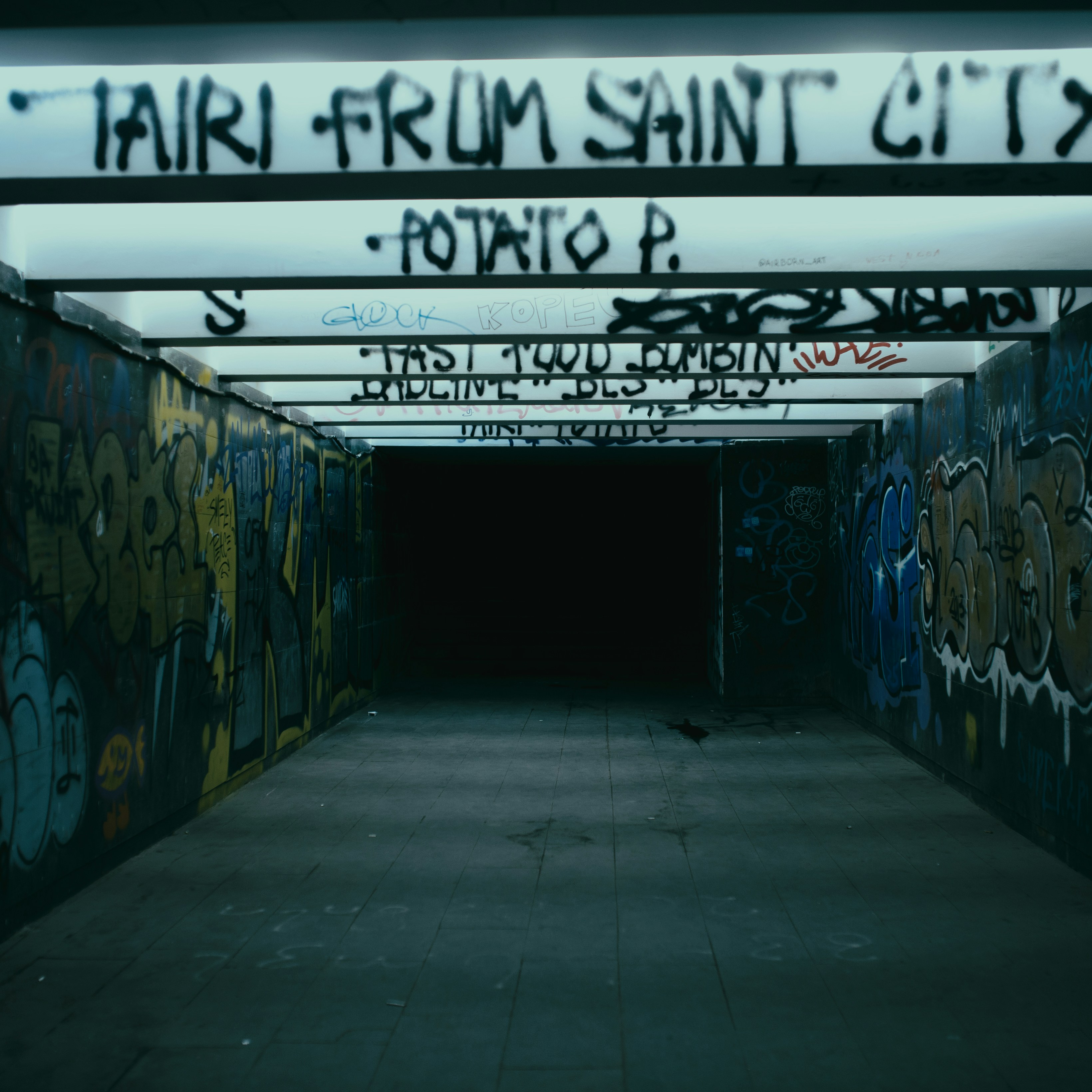 Centered Graffiti Tunnel: Depth Recedes into a Dark Portal
