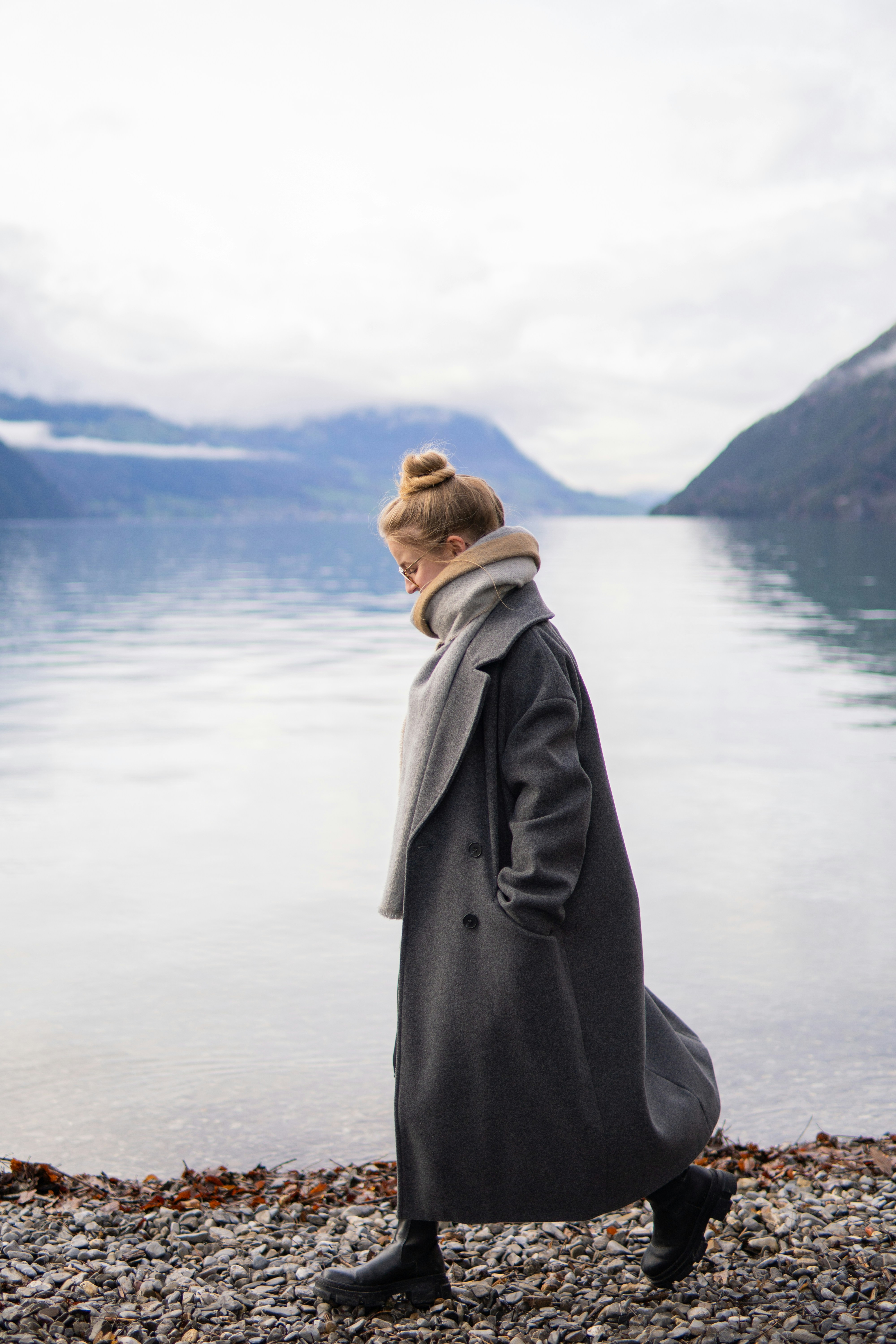 Solitary Fjord Stroll: A Woolen Figure by Glassy Waters