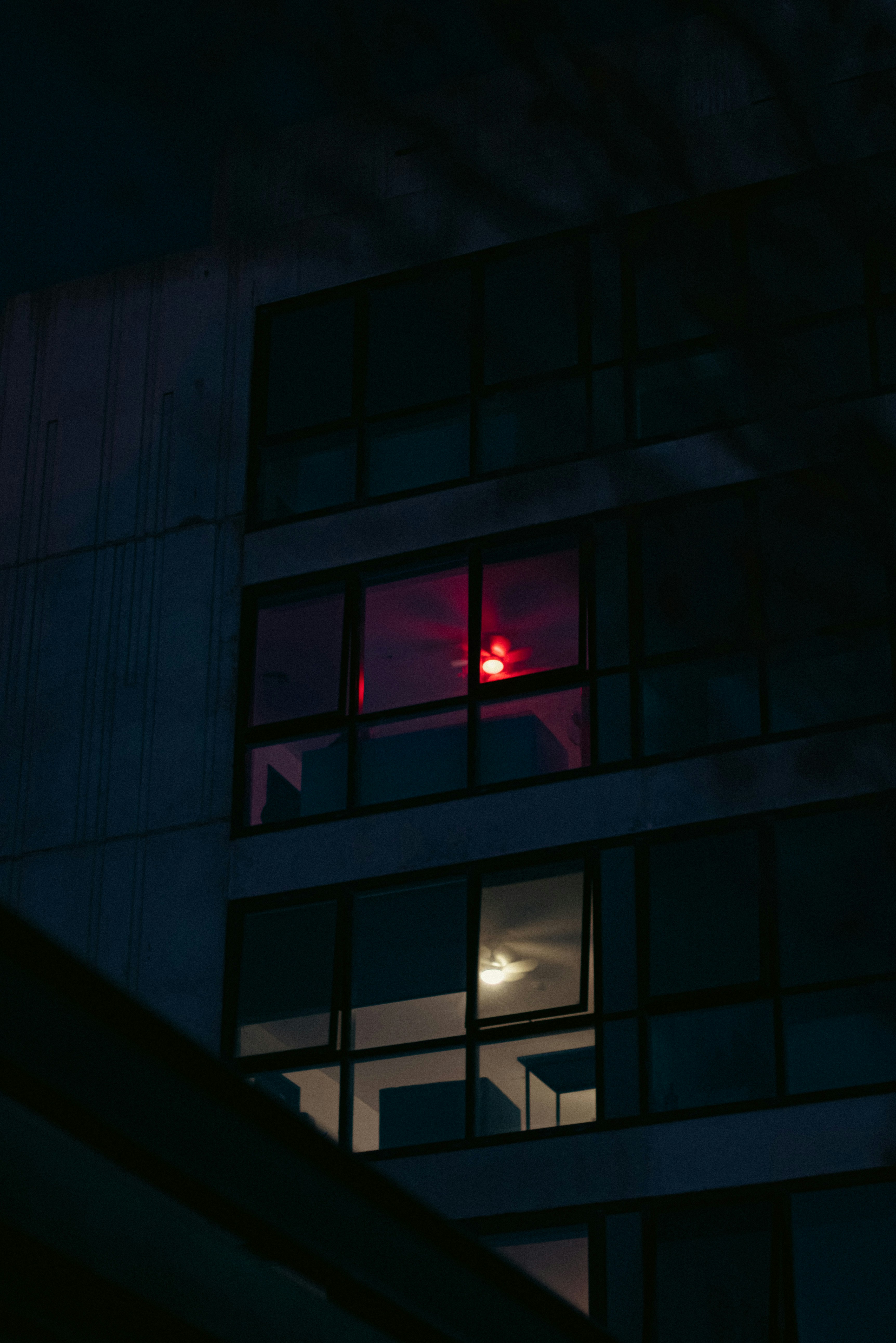 a building with a red light in the window