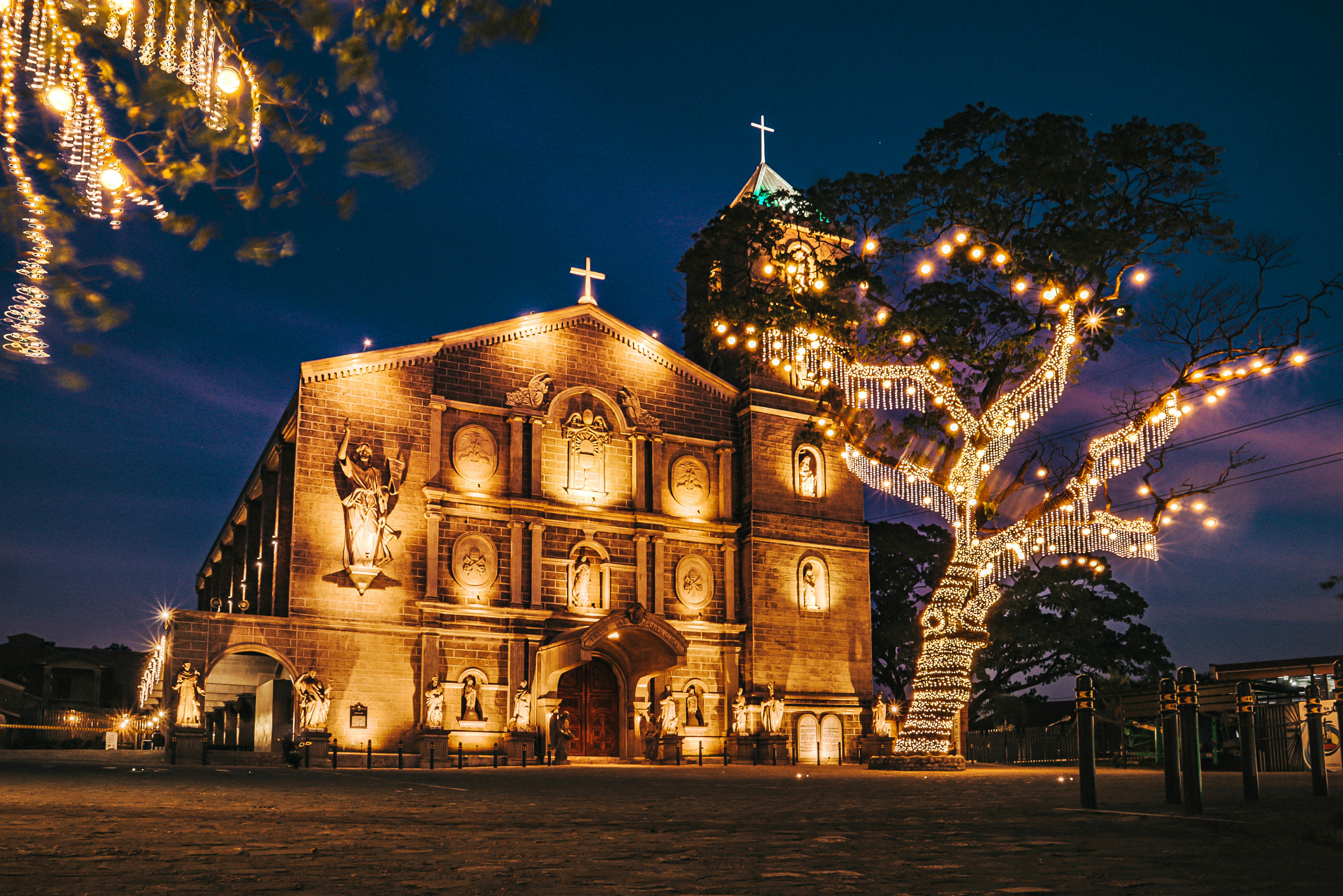 A church lit up at night with christmas lights photo – Free Rizal Image ...