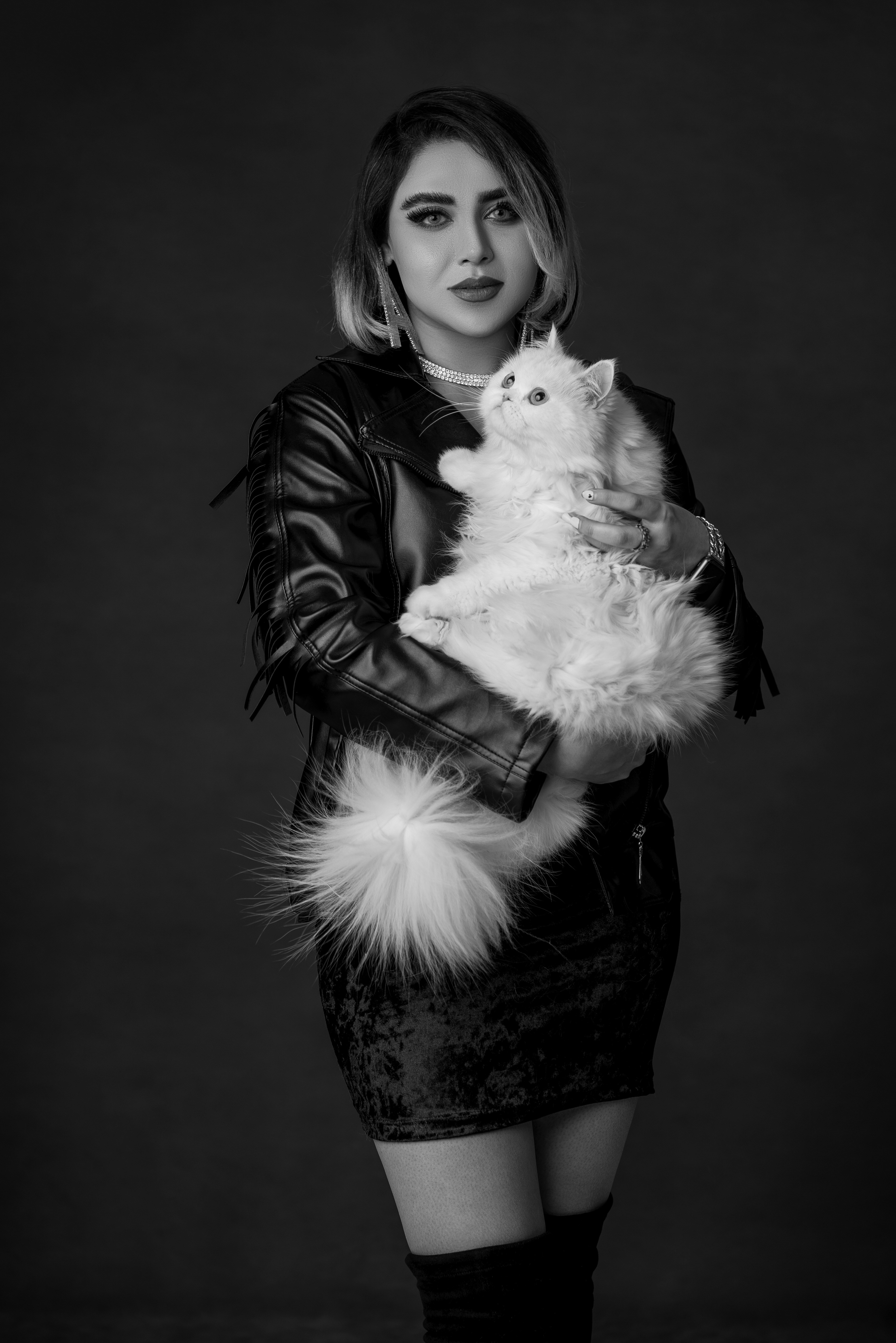 Leather and Snow: A Studio Portrait of Poise with a Fluffy Companion