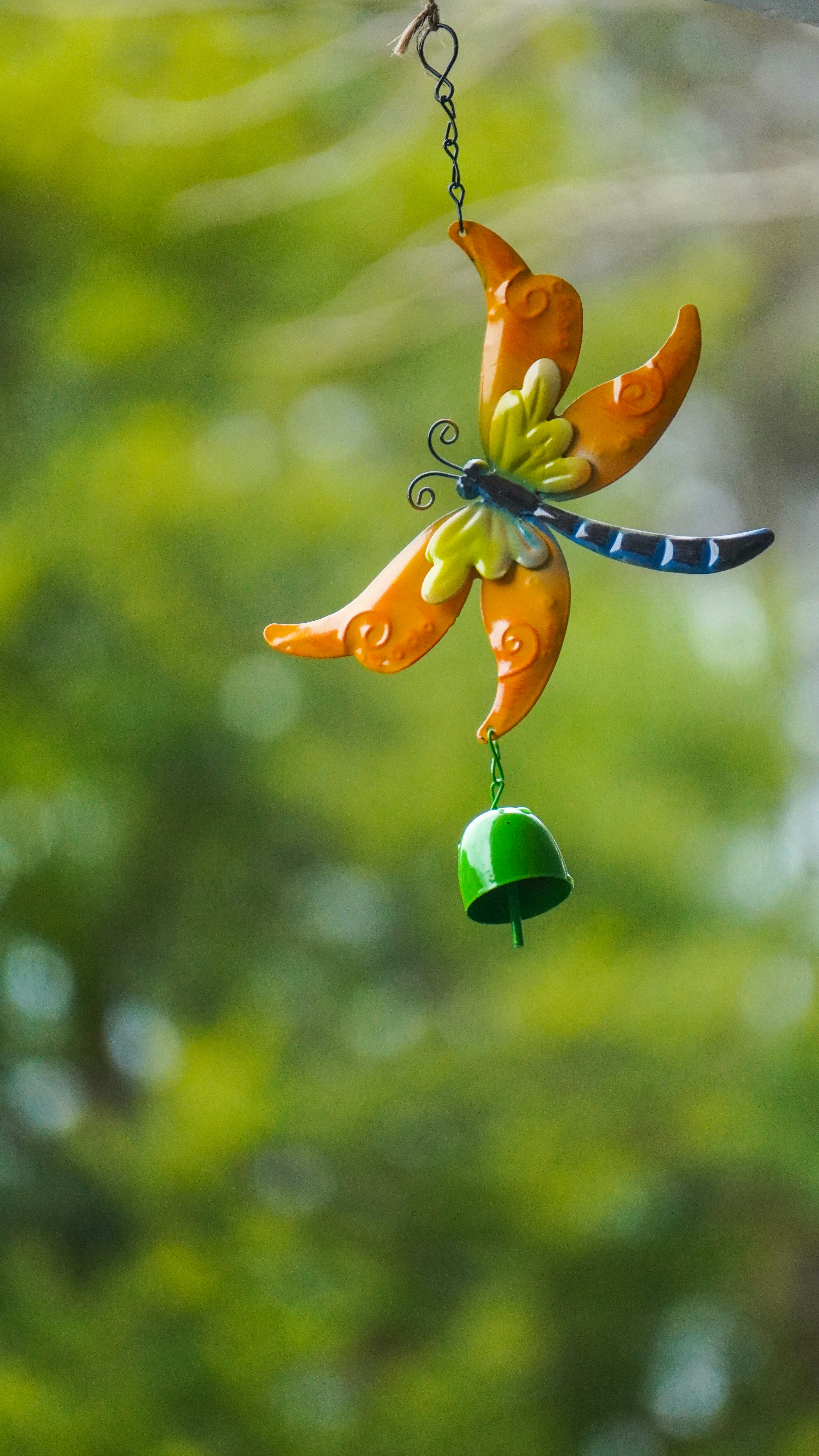 Floating Windcatcher: A Colorful Dragonfly Wind Spinner in Focus