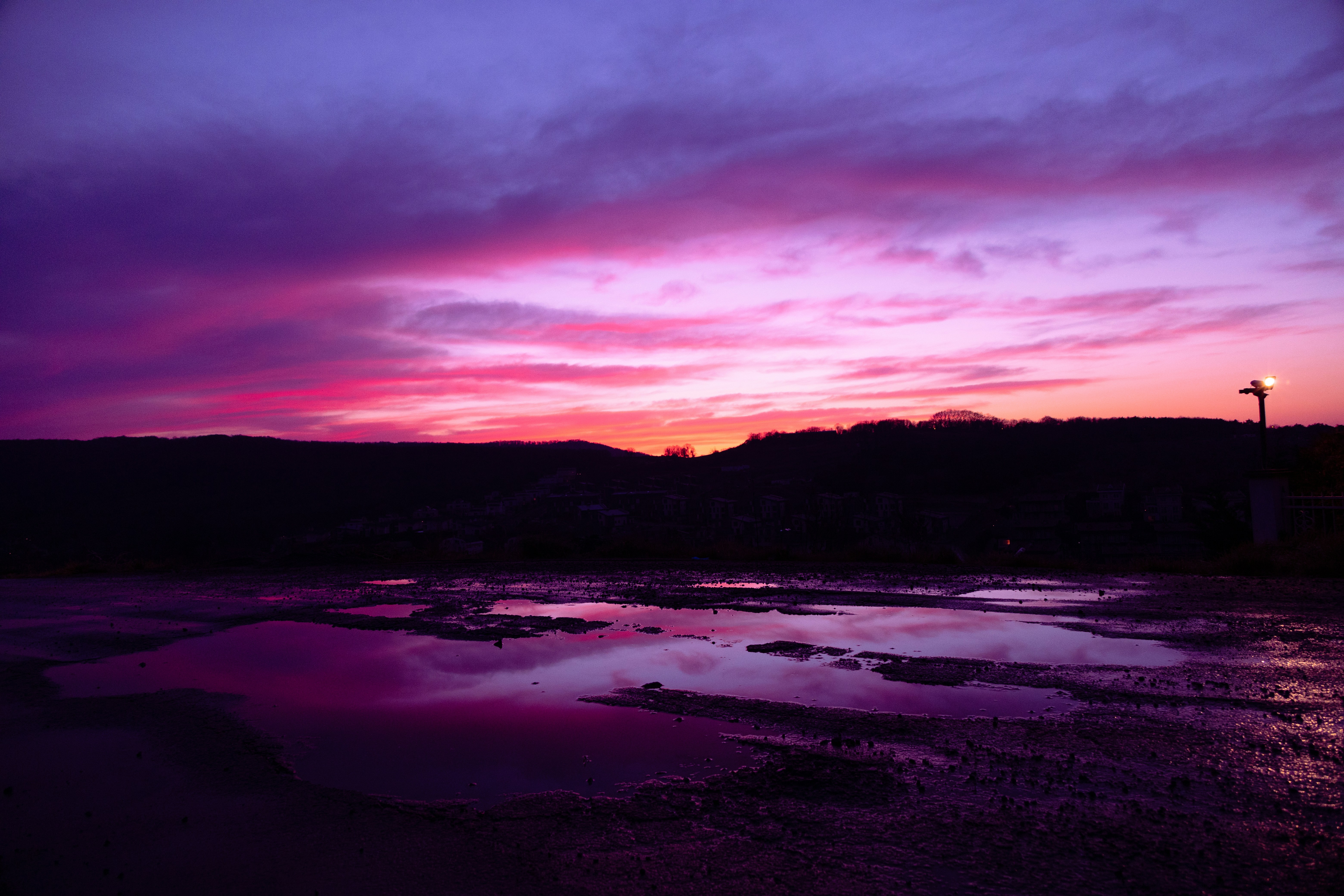 a purple and pink sunset over a body of water