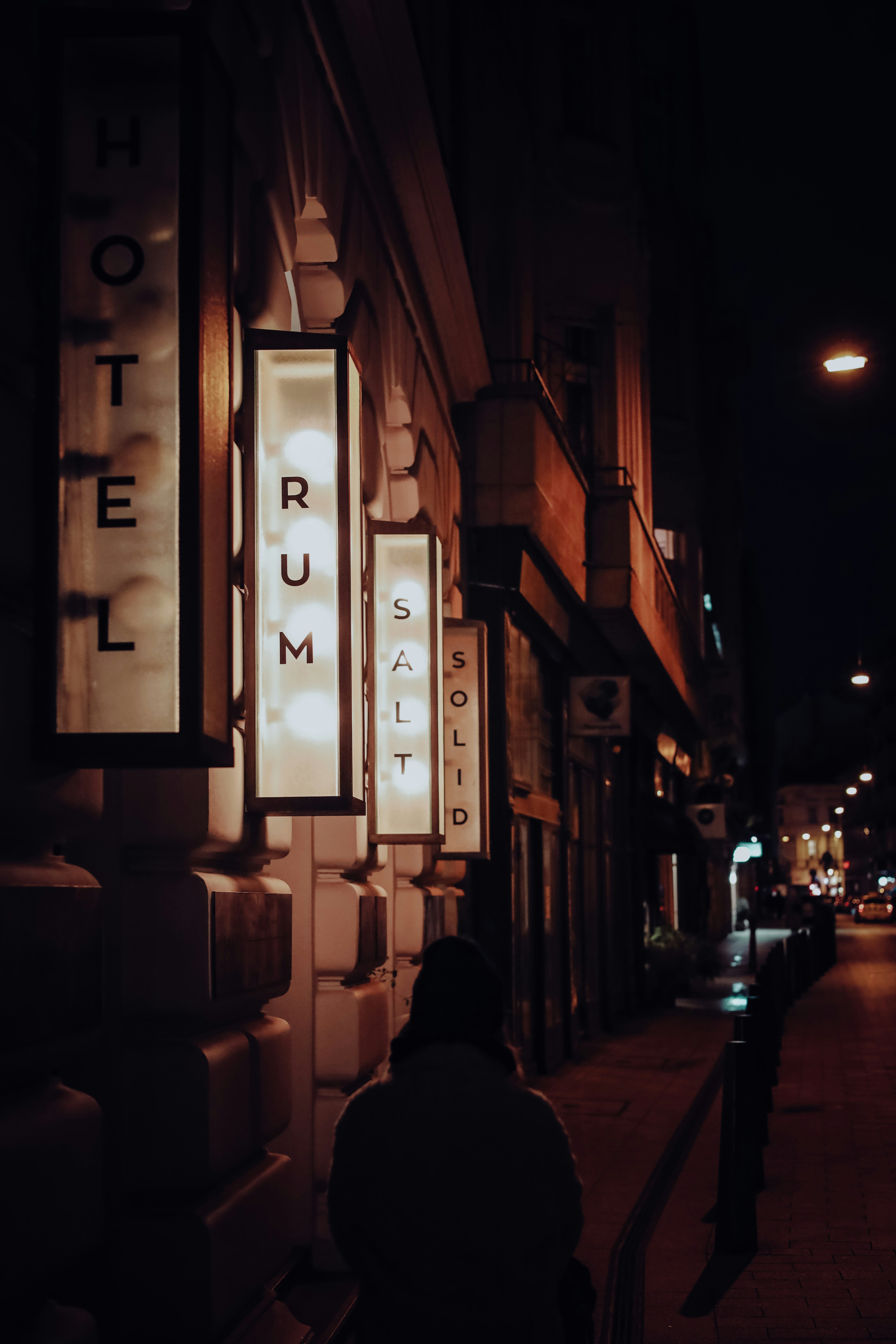 Amber Neon Elegy Along a Nighttime Hotel Row