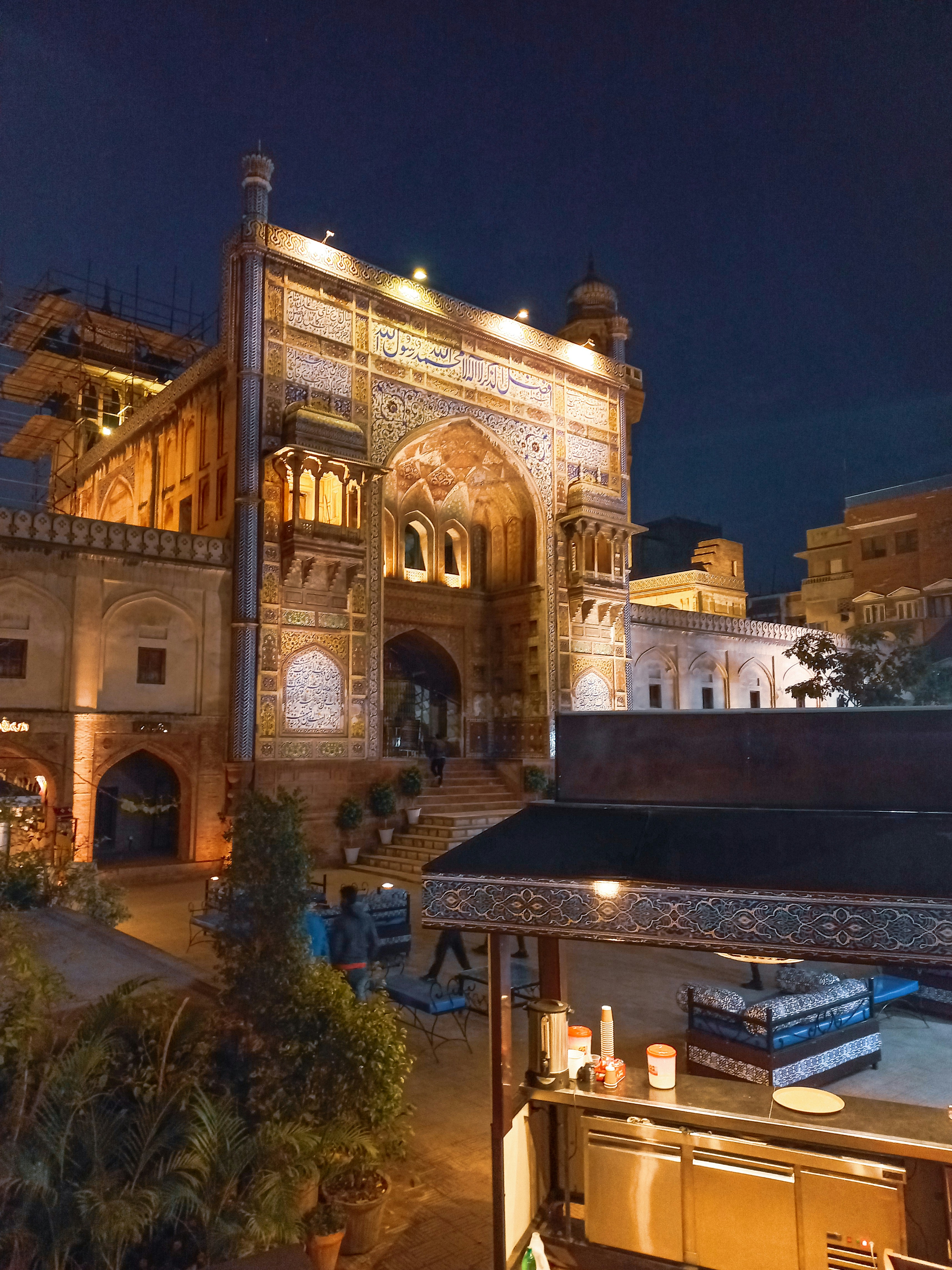 A building lit up at night with lights on photo – Free Lahore Image on ...