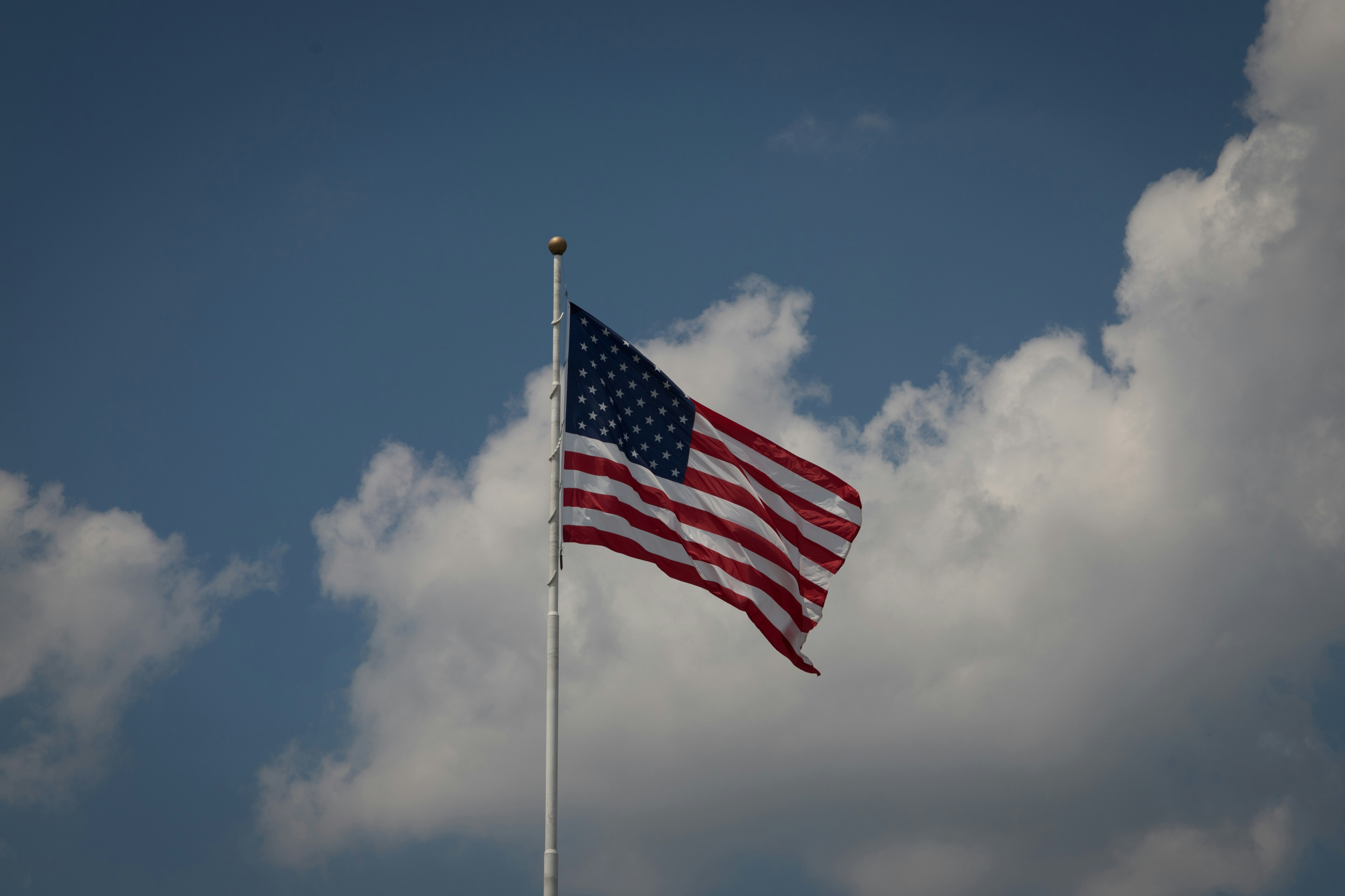 A large american flag flying in the sky photo – Free Usa Image on Unsplash