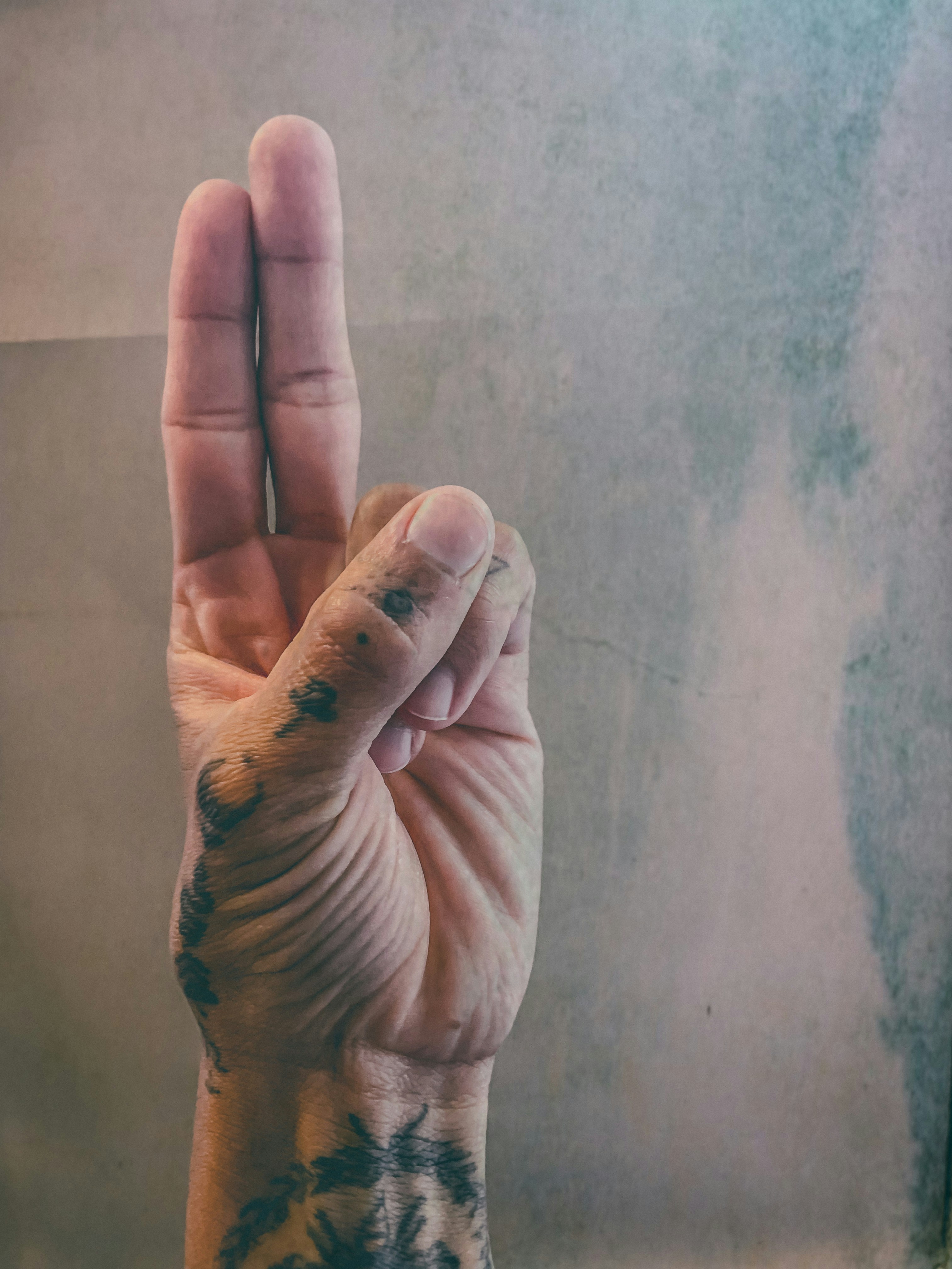 A person's hand with a tattoo on it photo – Free Sword mudra Image on ...