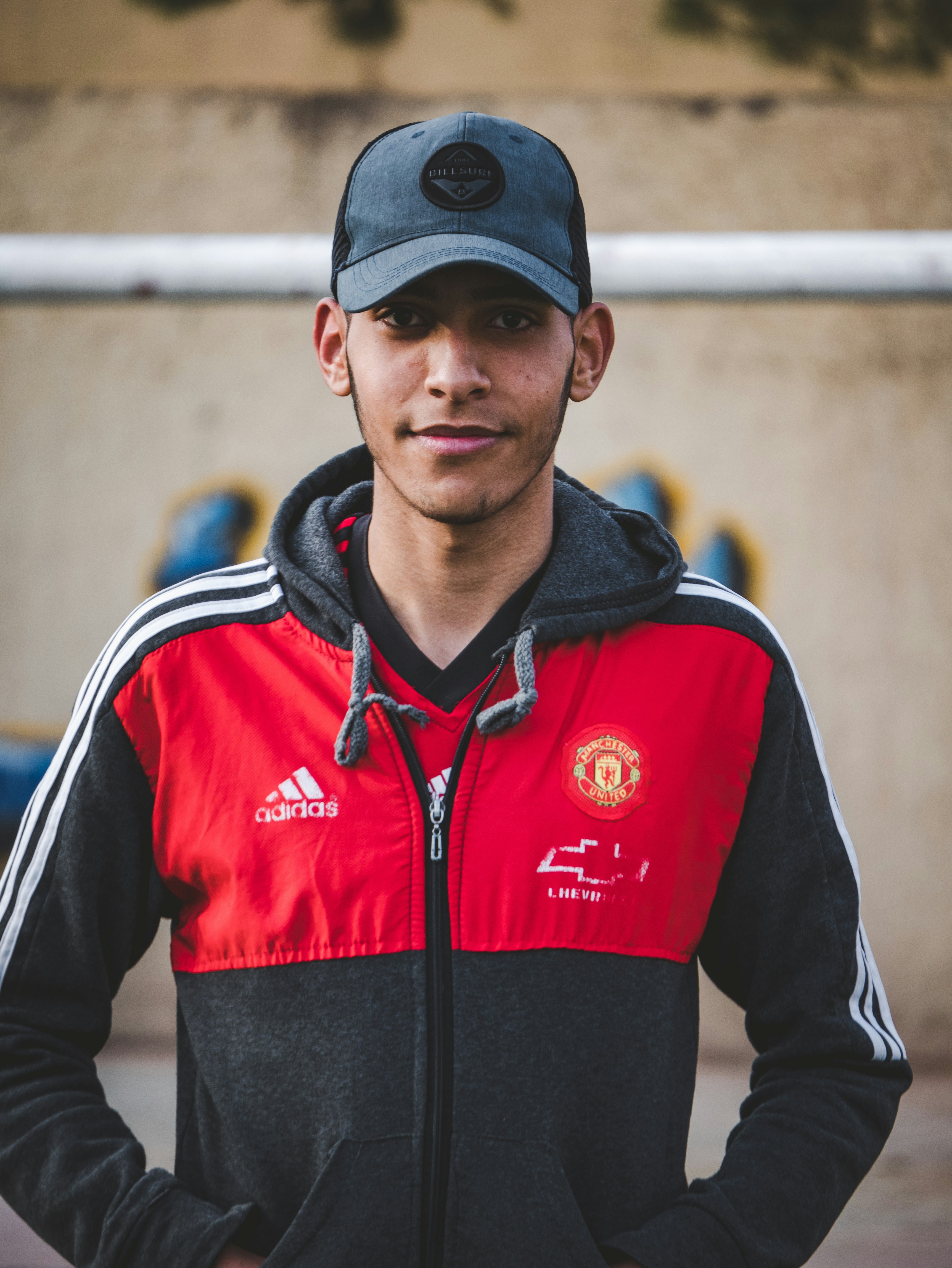 A man in a red and black jacket and hat photo – Free Portrait Image on ...