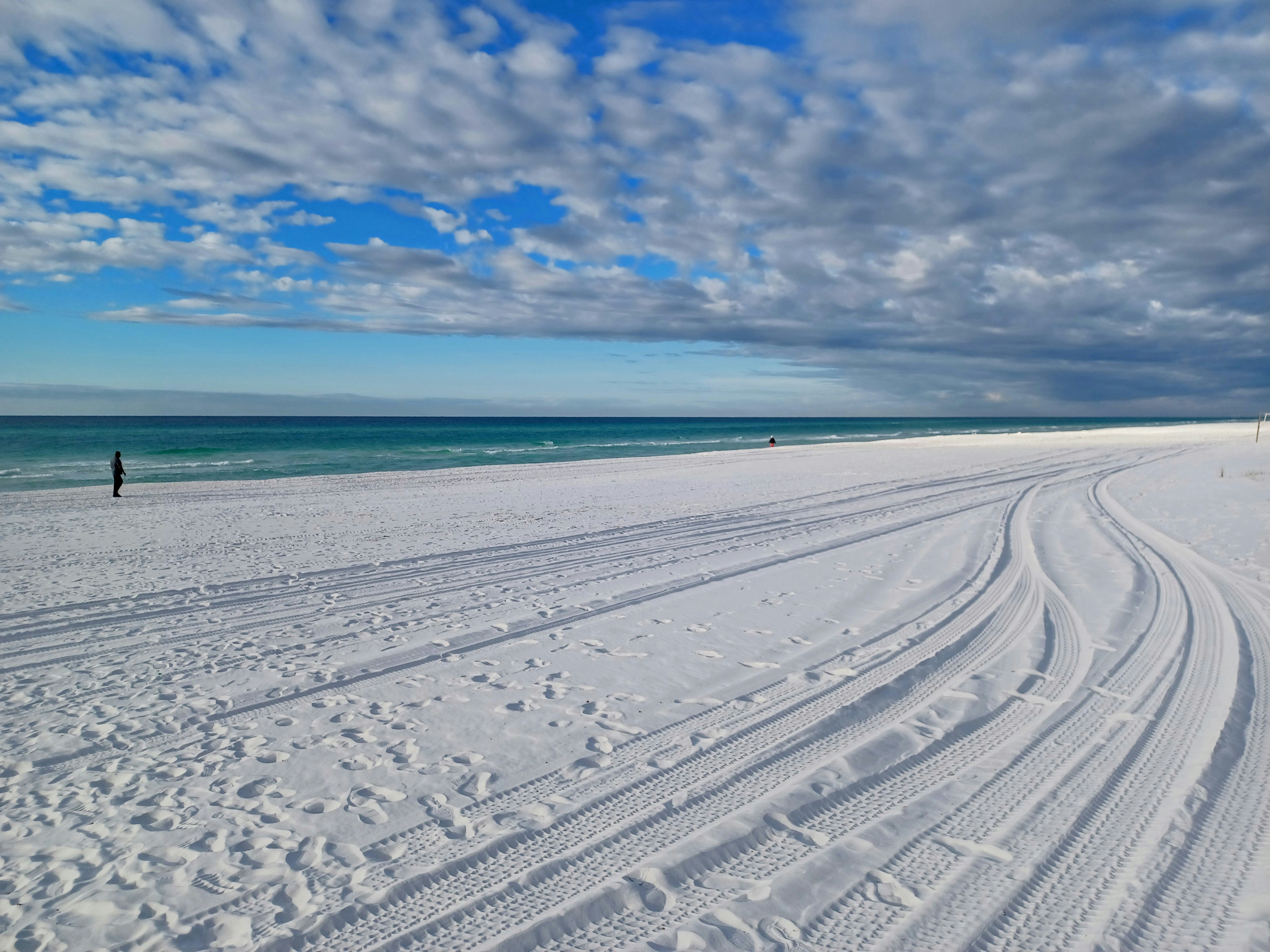 A sandy beach with tracks in the sand photo – Free Image on Unsplash