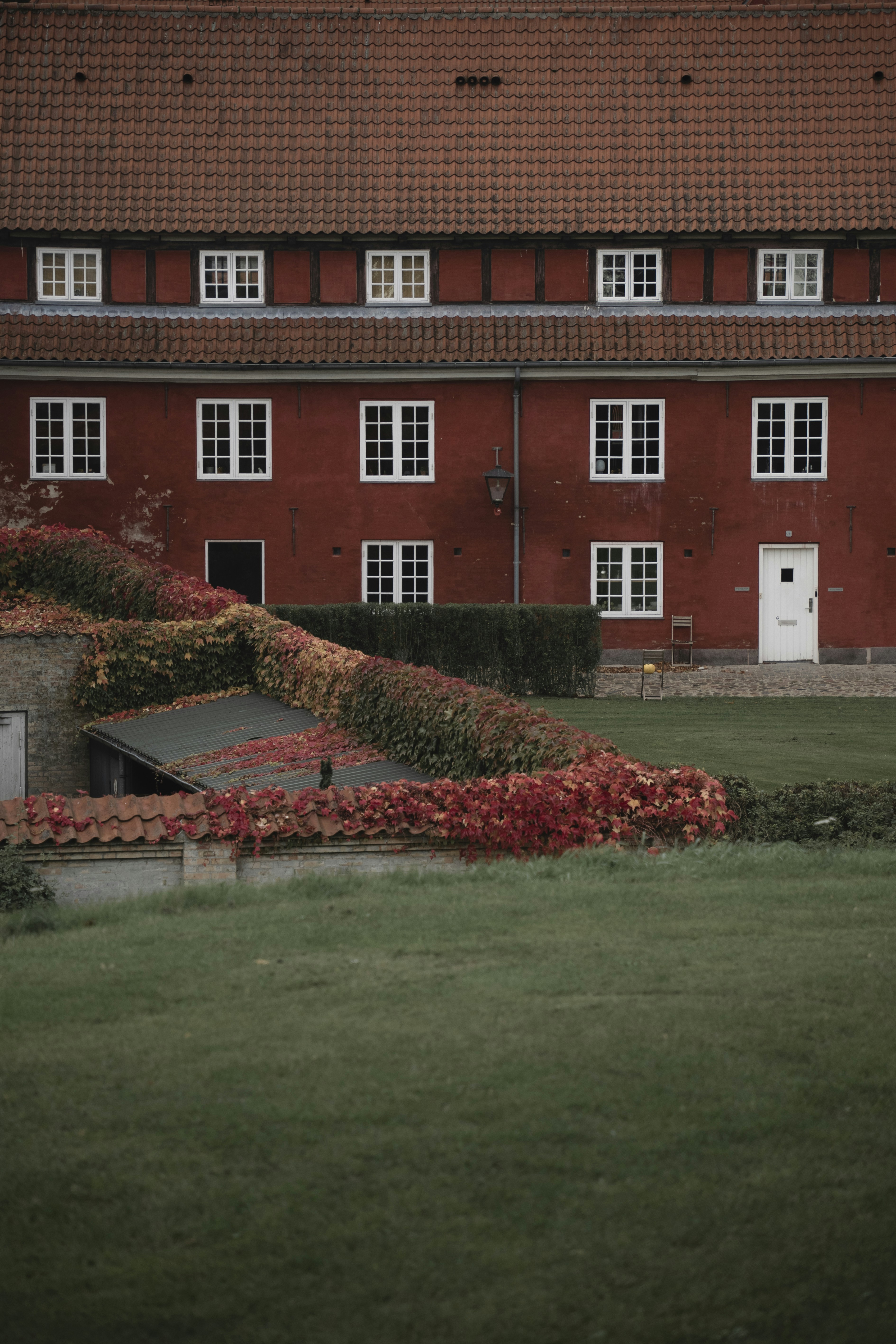 a red building with a white door and windowsJonas Schöne