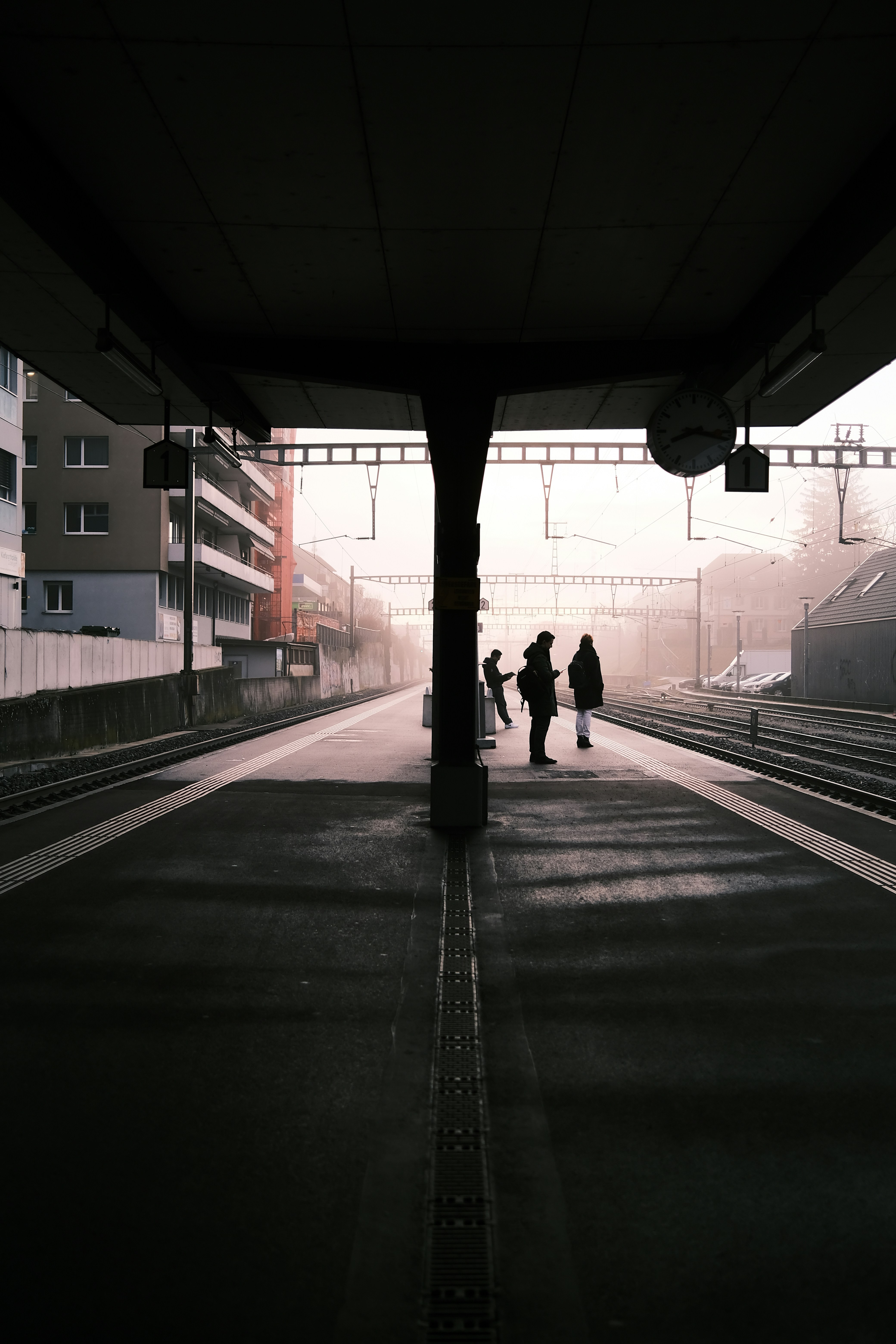 A group of people standing on a train platform photo – Free Moring ...