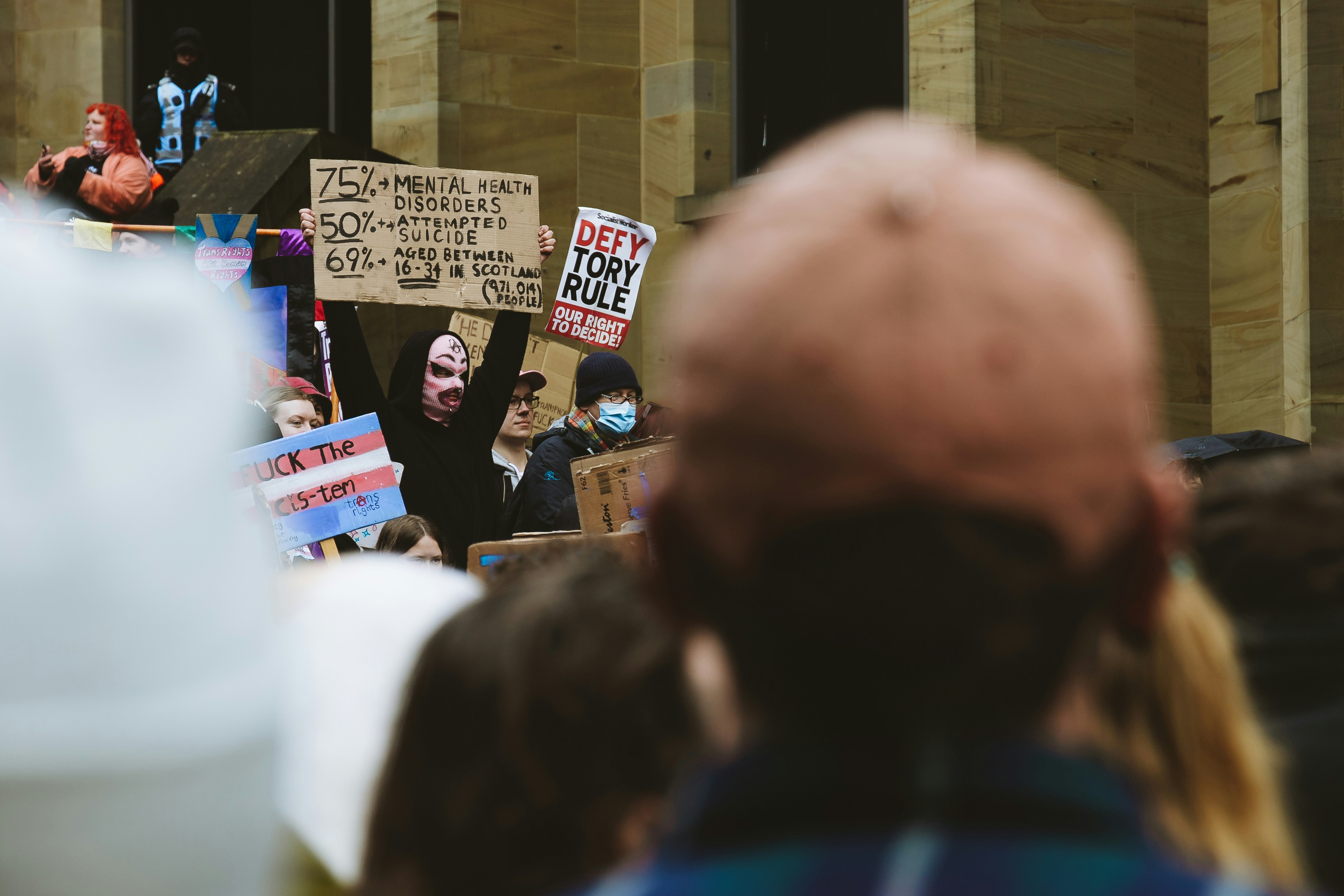 A crowd of people holding signs and wearing masks photo – Free Protests ...