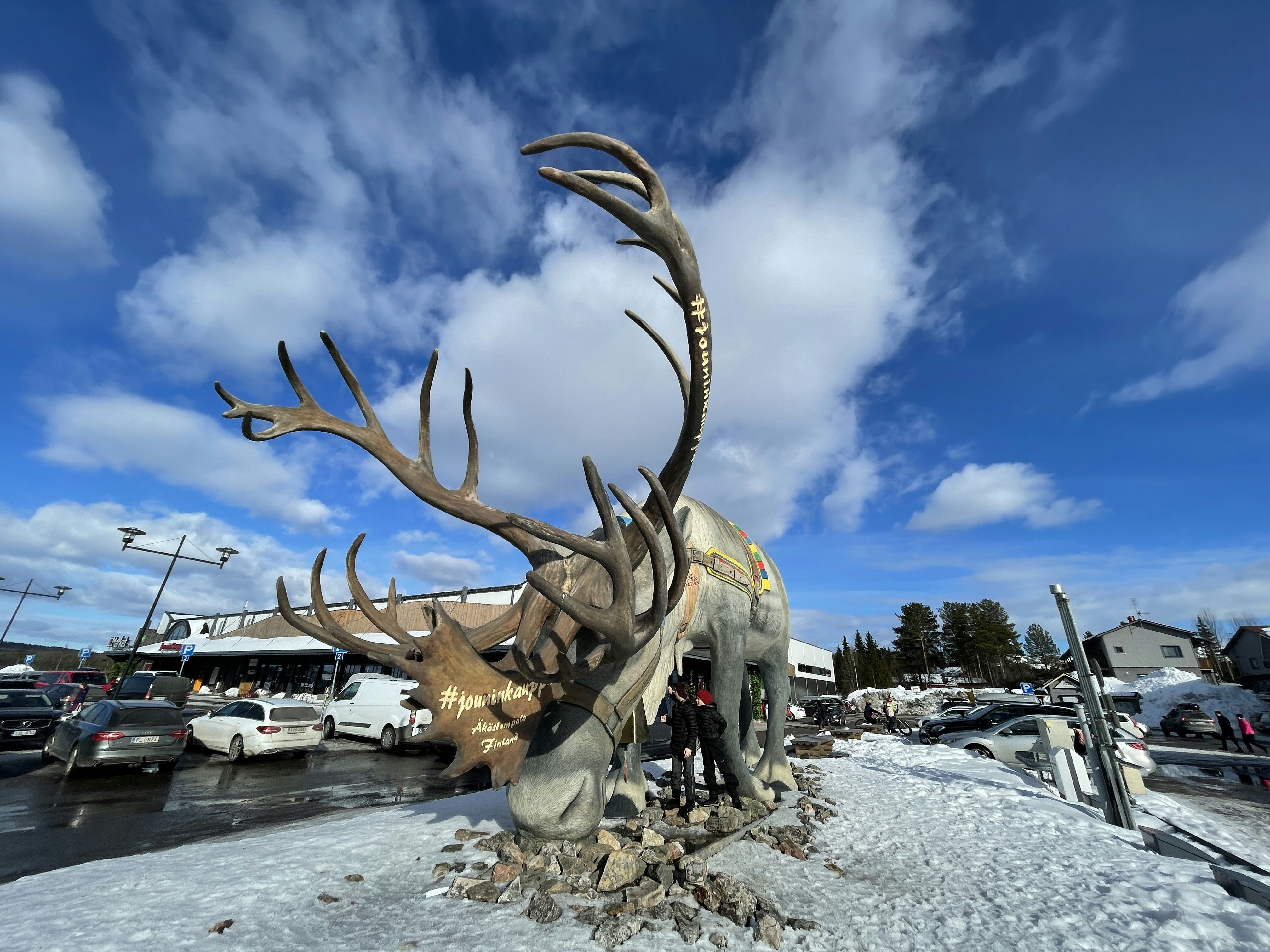 A statue of a deer with large antlers in a parking lot photo – Free ...