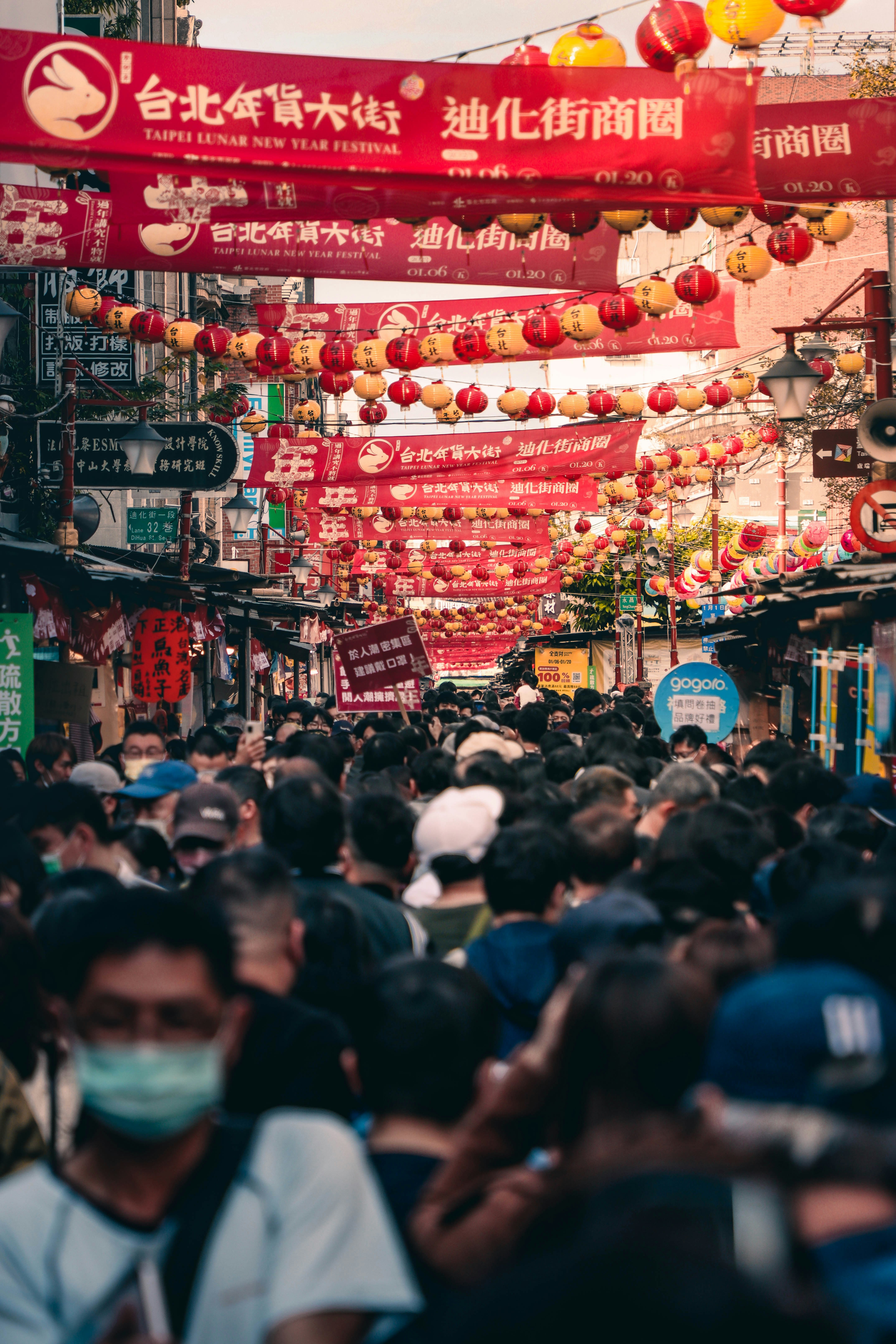 A crowd of people walking down a crowded street photo – Free People ...