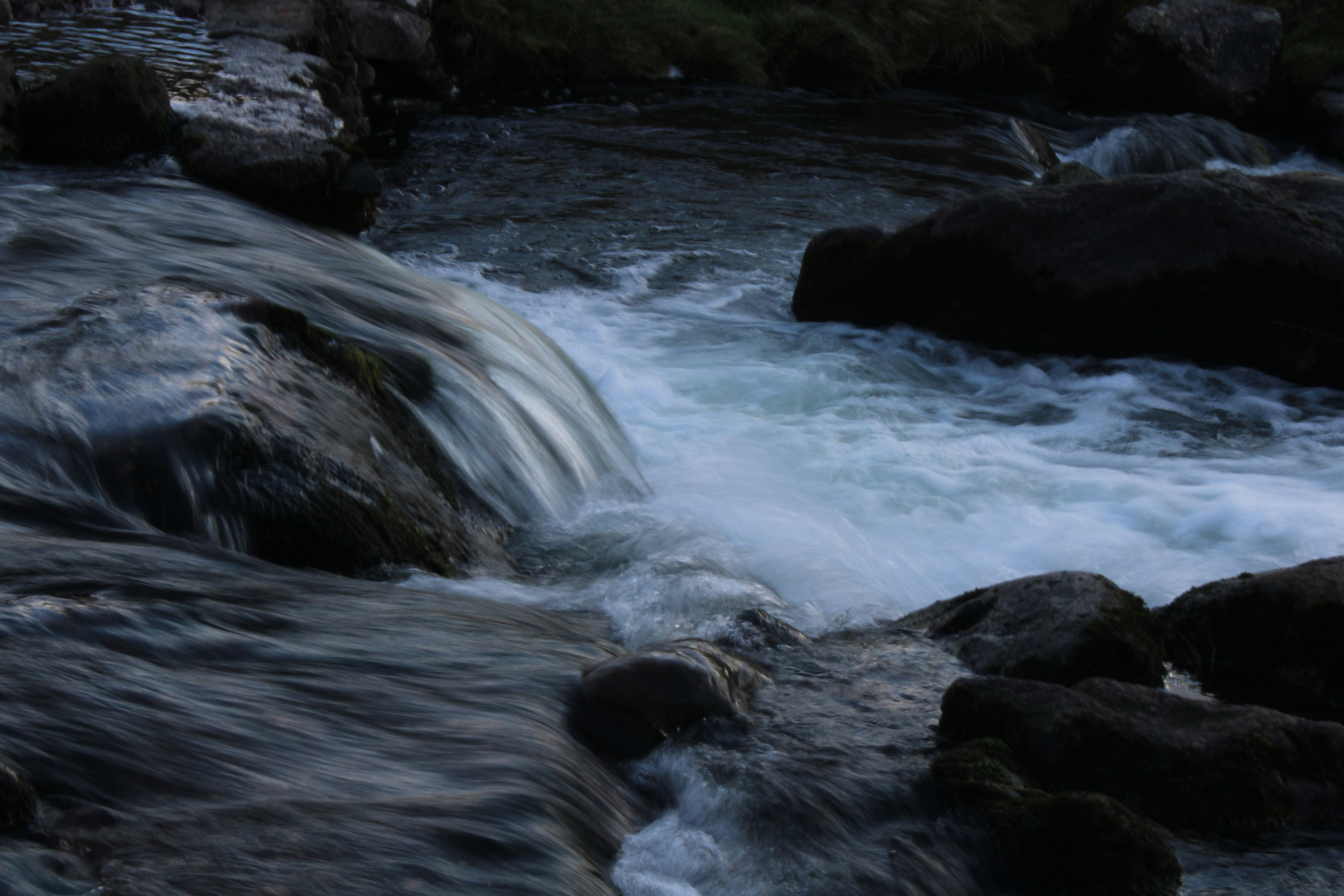 A stream of water running over rocks in a river photo – Free Water ...