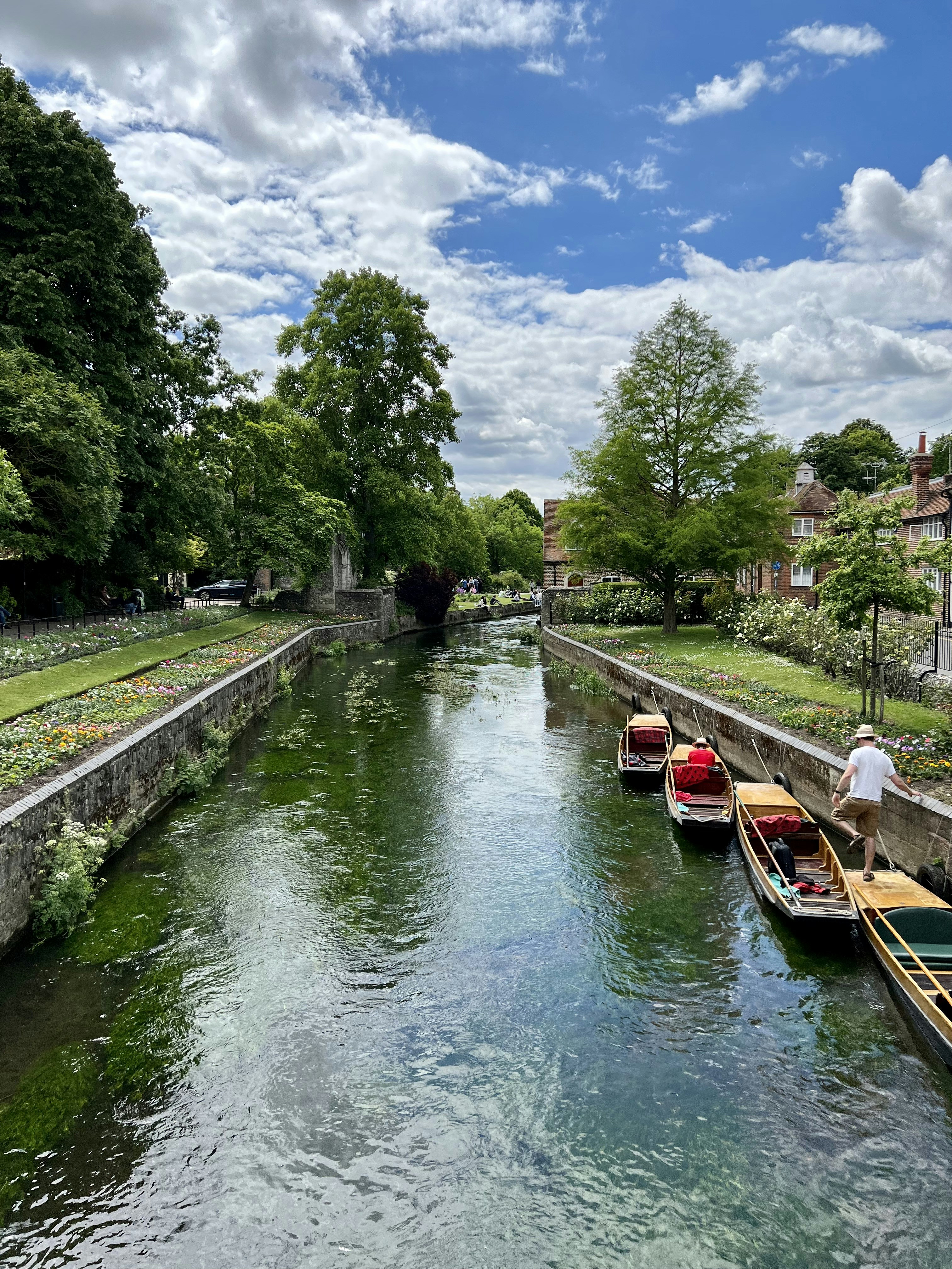 Towpath Tranquility: Boats Beside a Sunlit Canal Framed by Greenery