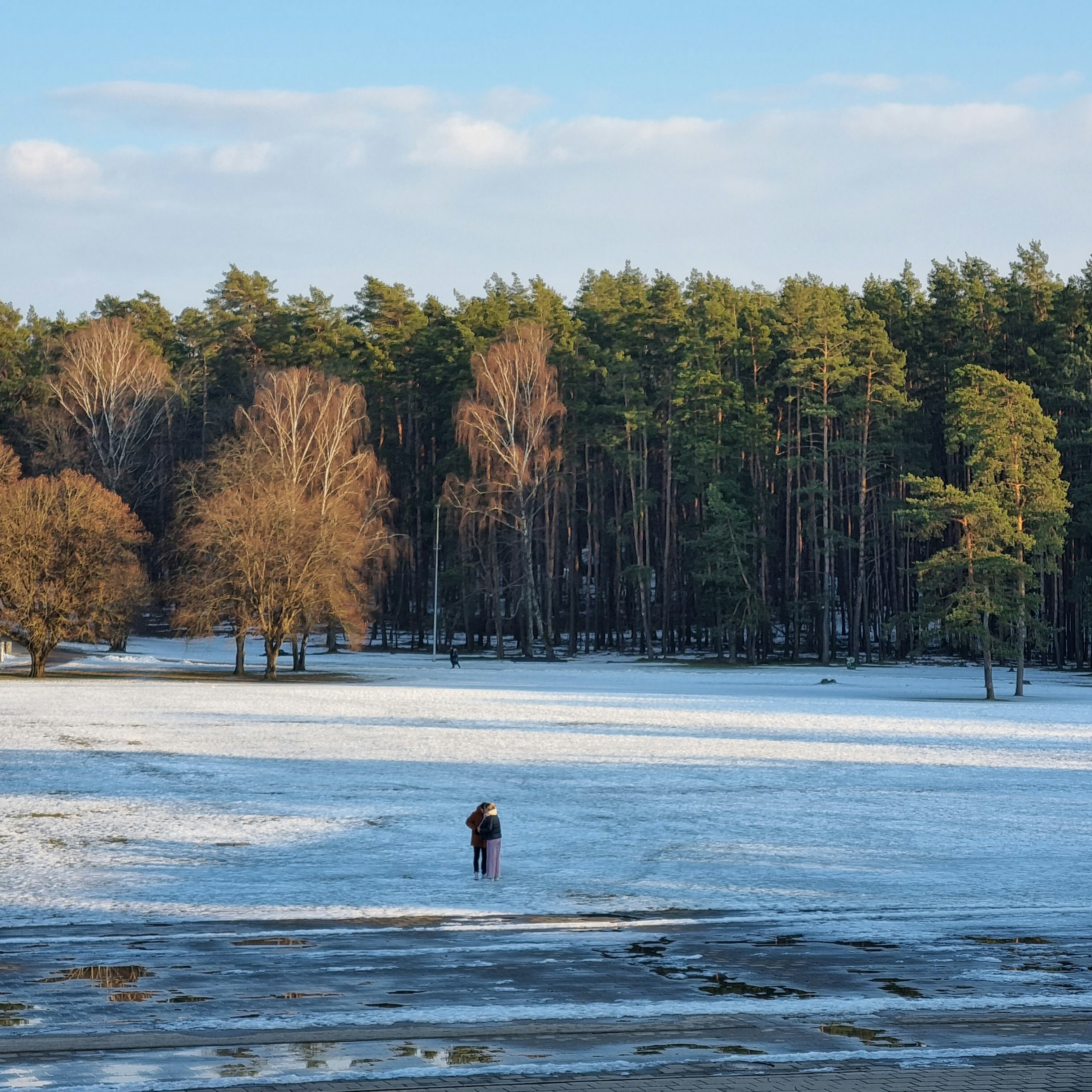a person standing in the middle of a frozen lake