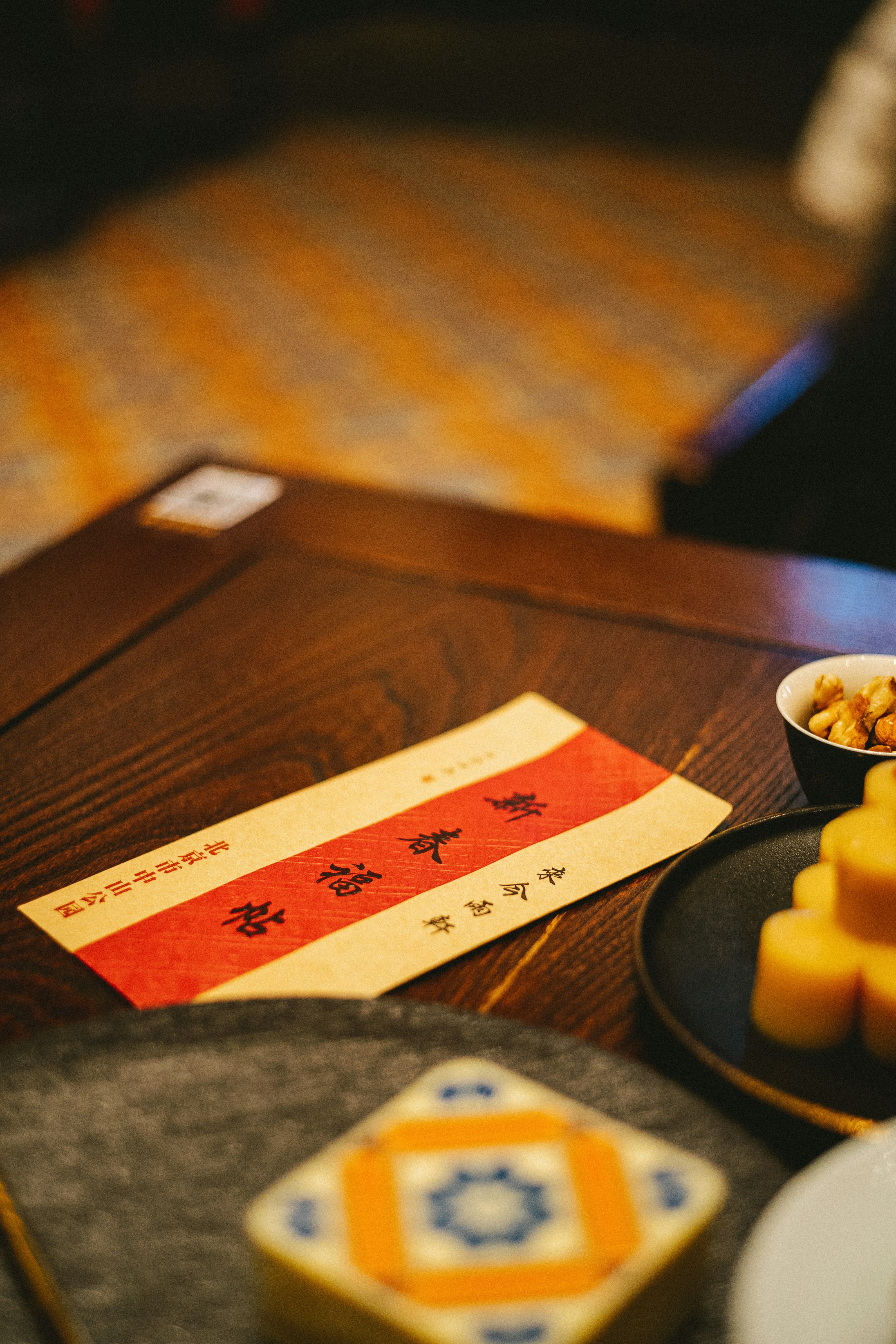 Crimson Ribbon on Walnut: A Quiet Moment on a Restaurant Table