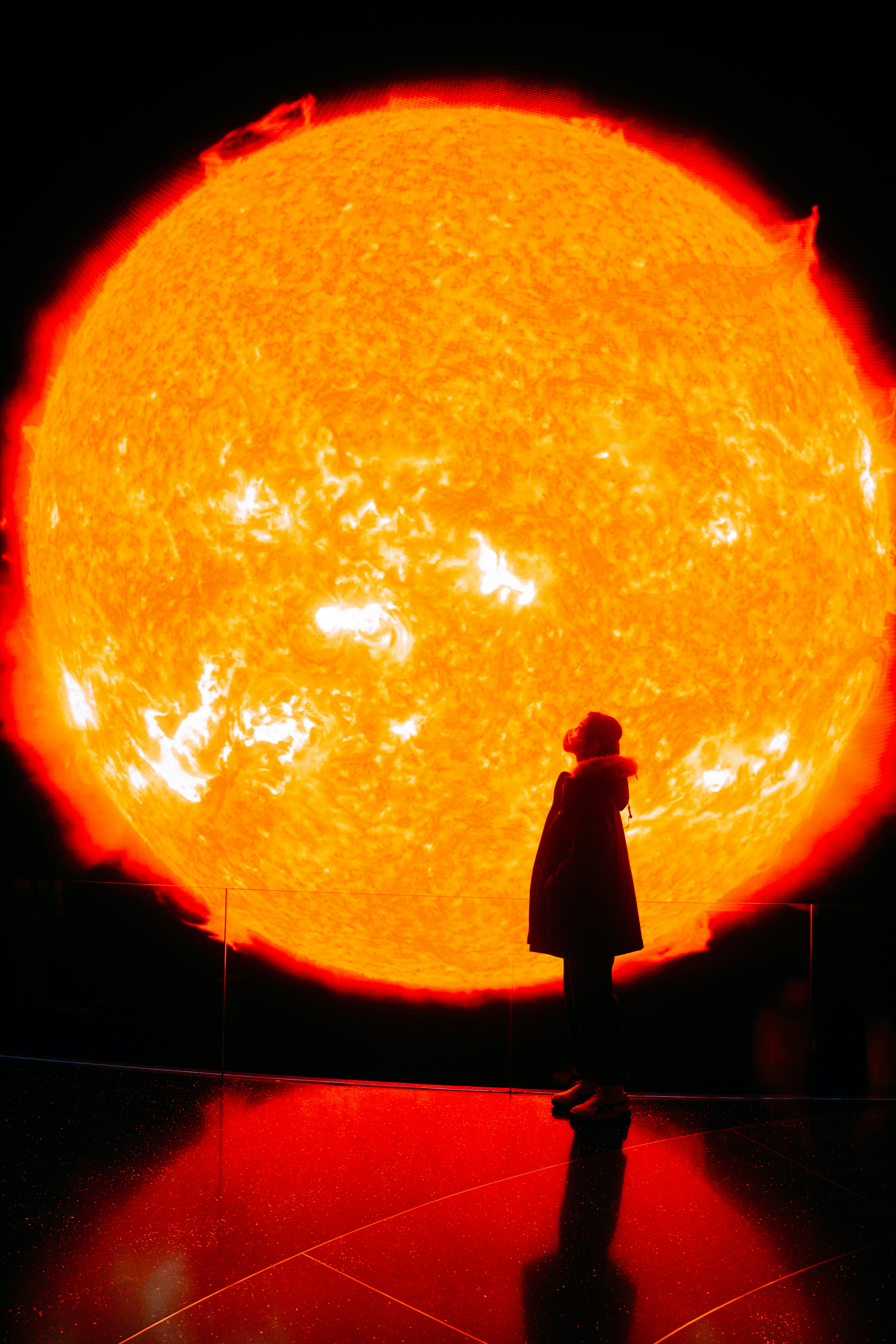 A person standing in front of a large sun photo – Free Woman Image on ...