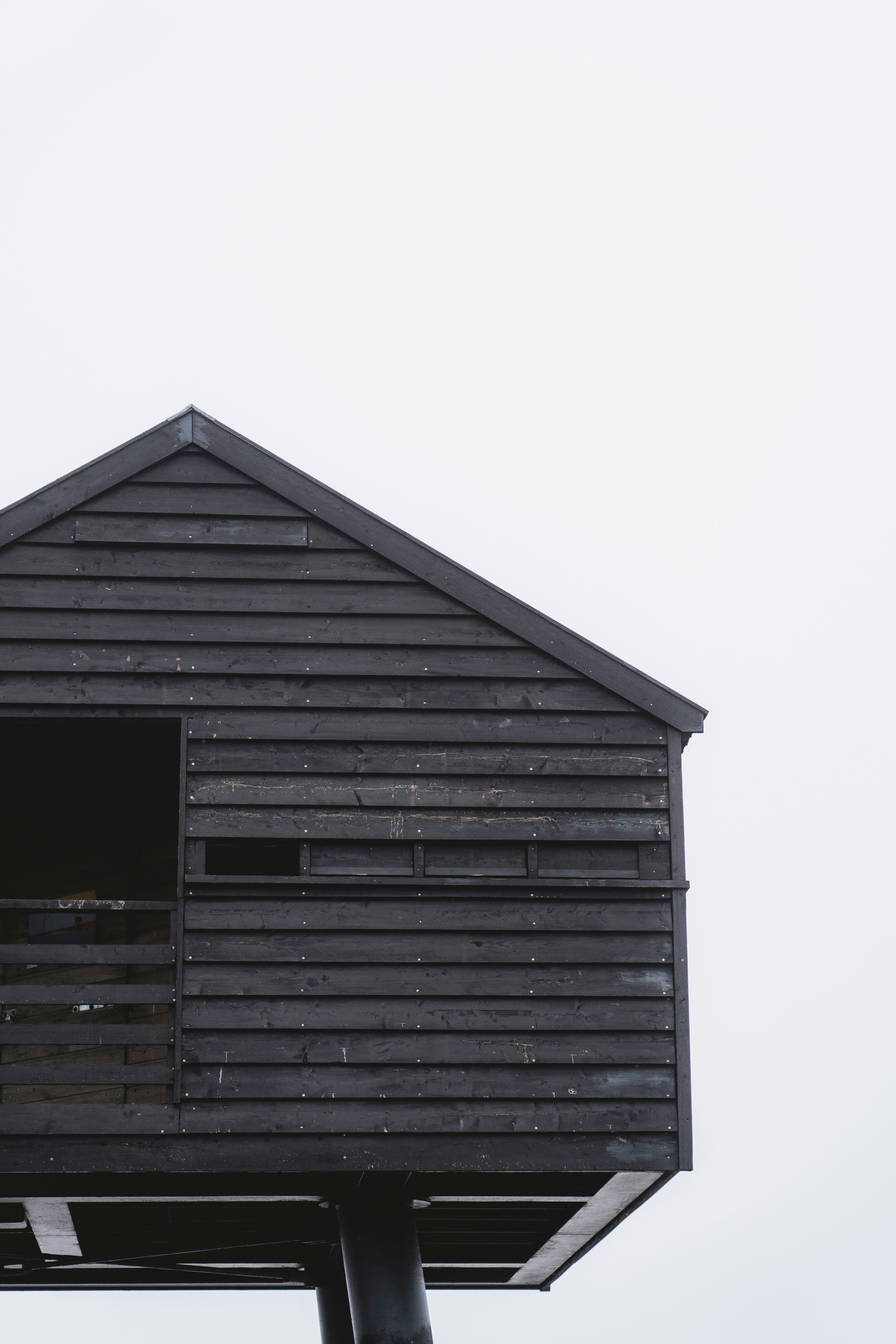 Dark Wood Cabin against Pale Sky