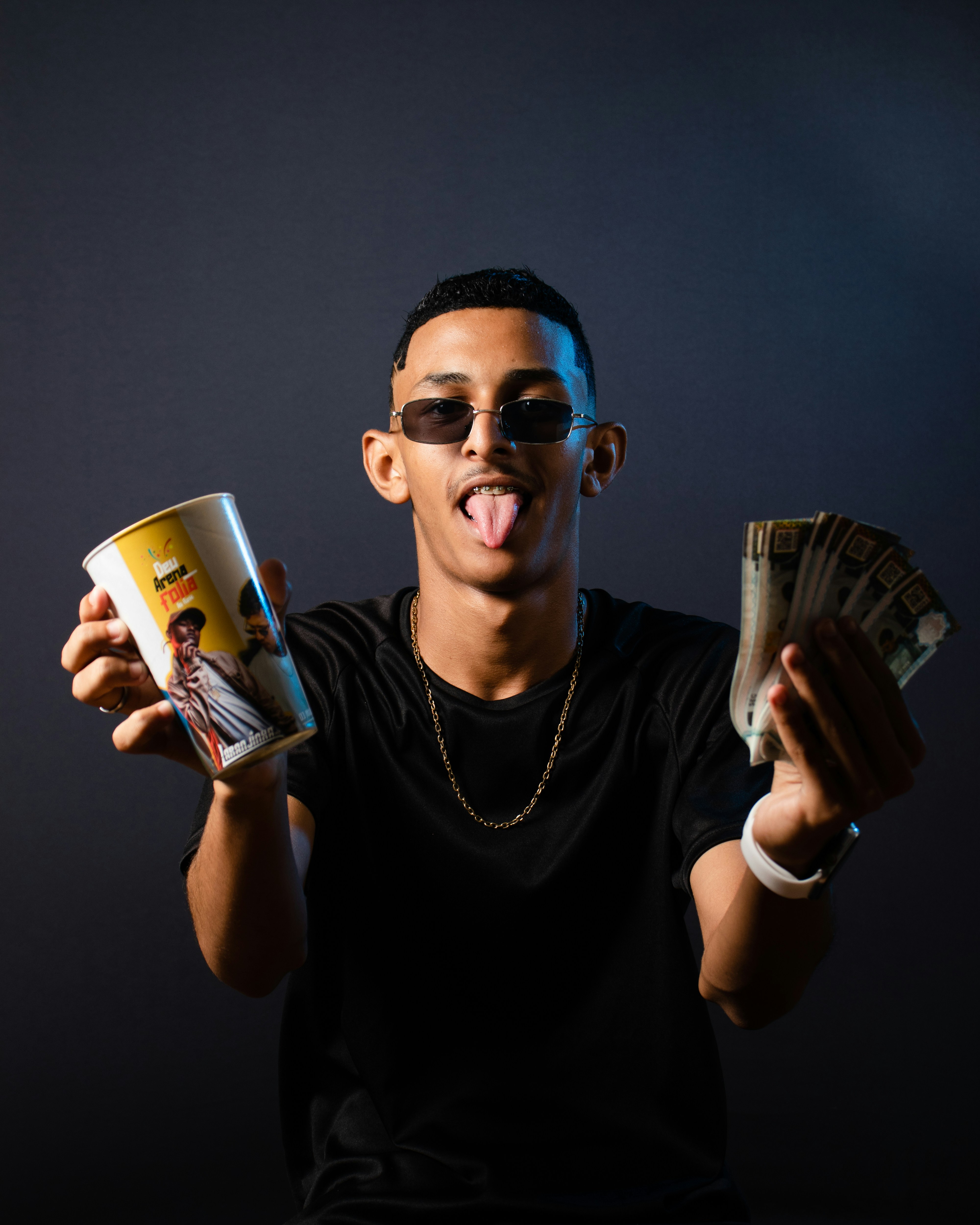 A man holding a cup and money in his hands photo – Free Portrait Image ...