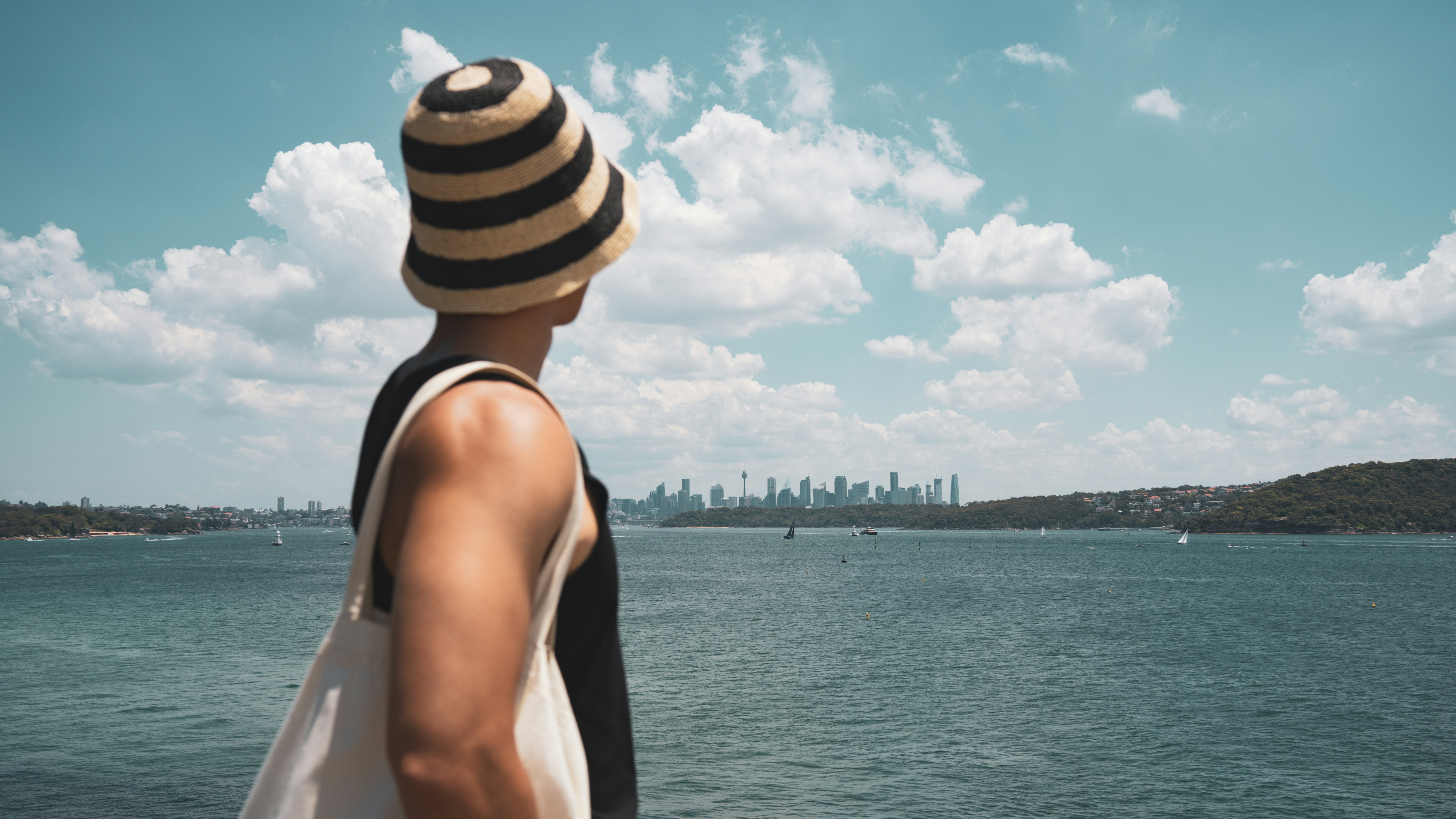 Stripes at the Shore: A Back-Facing Portrait with a Distant City Horizon
