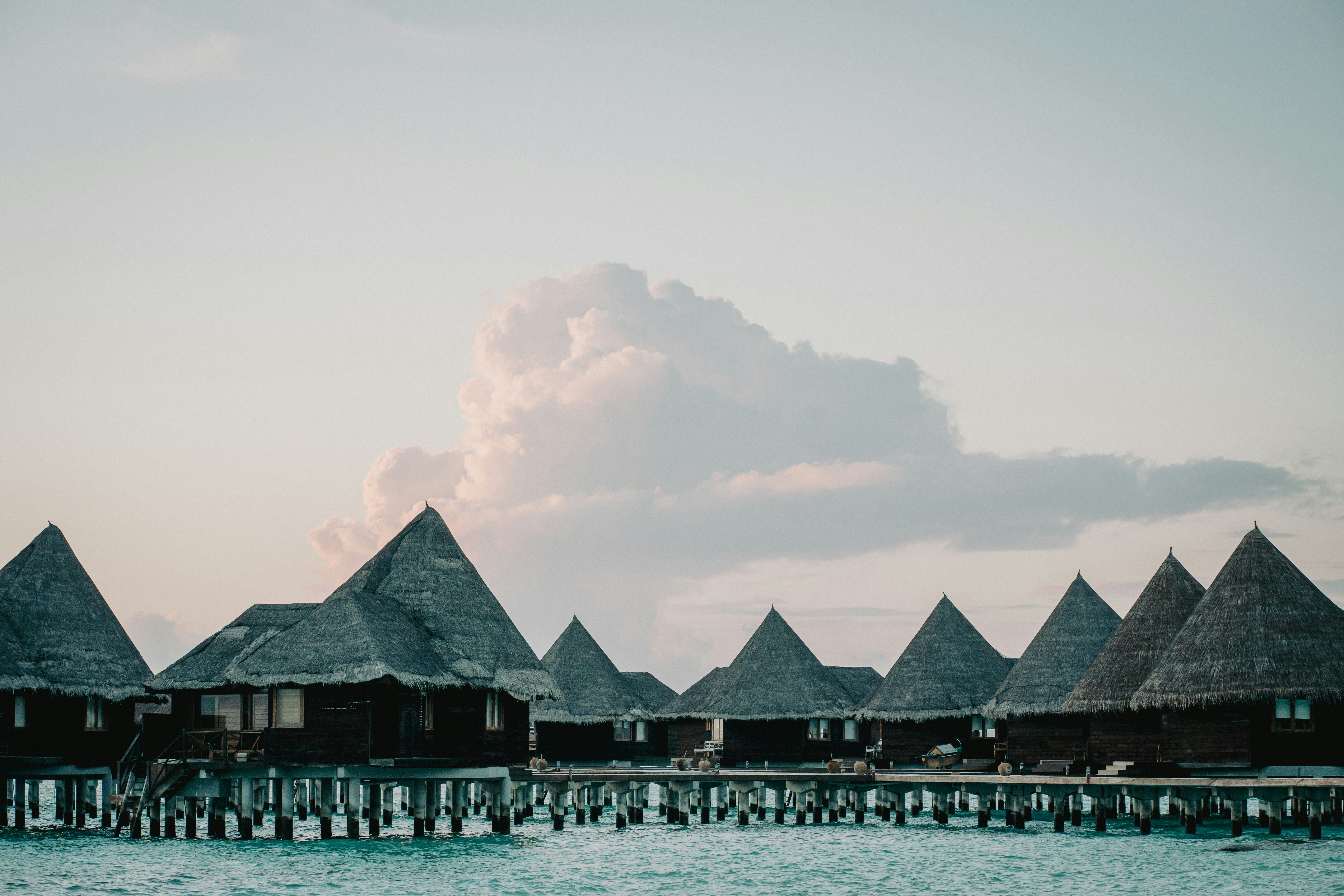 Horizon of Thatched Terraces: Overwater Bungalows Along a Quiet Lagoon