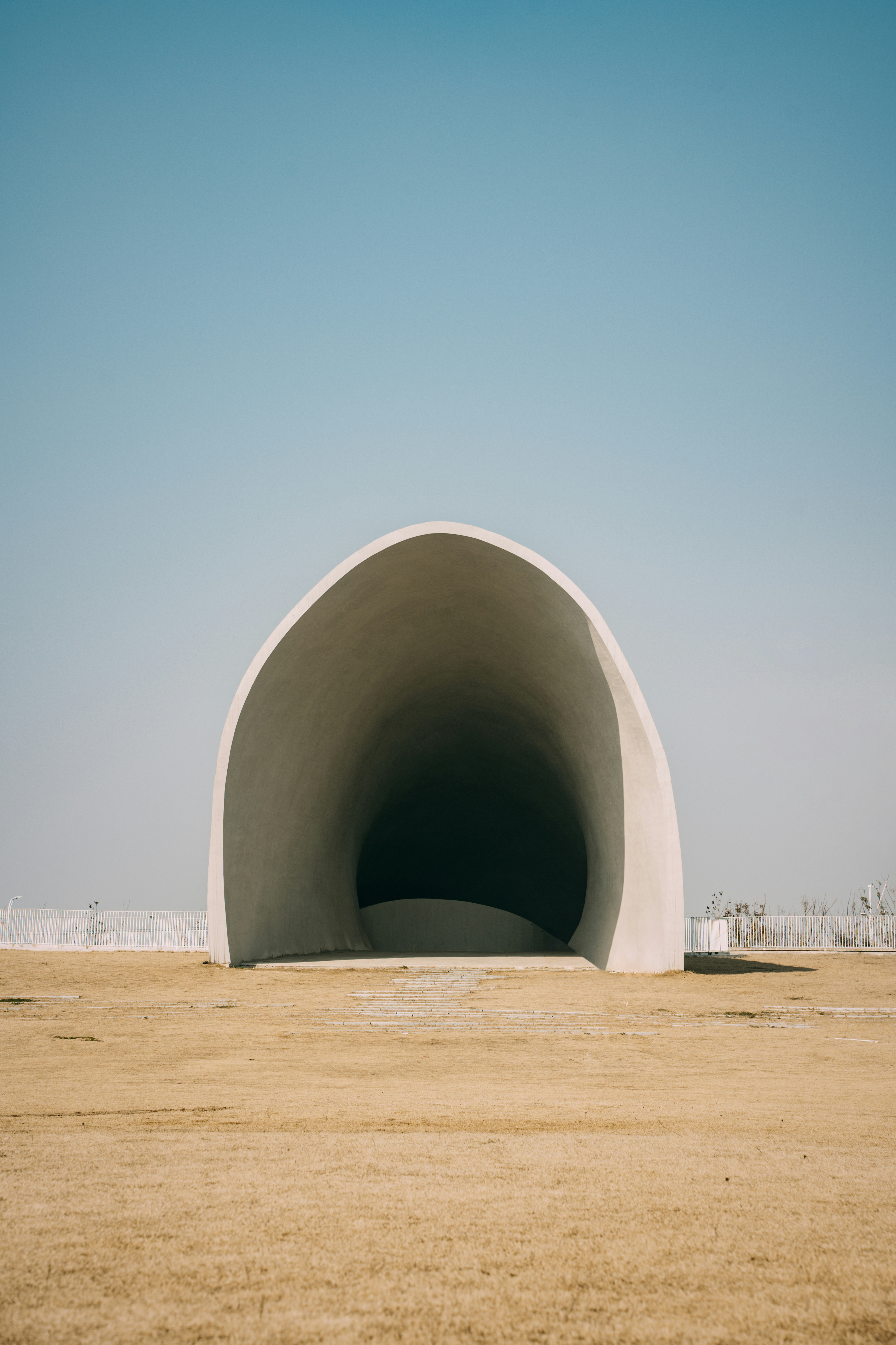 A large concrete structure sitting in the middle of a field photo ...