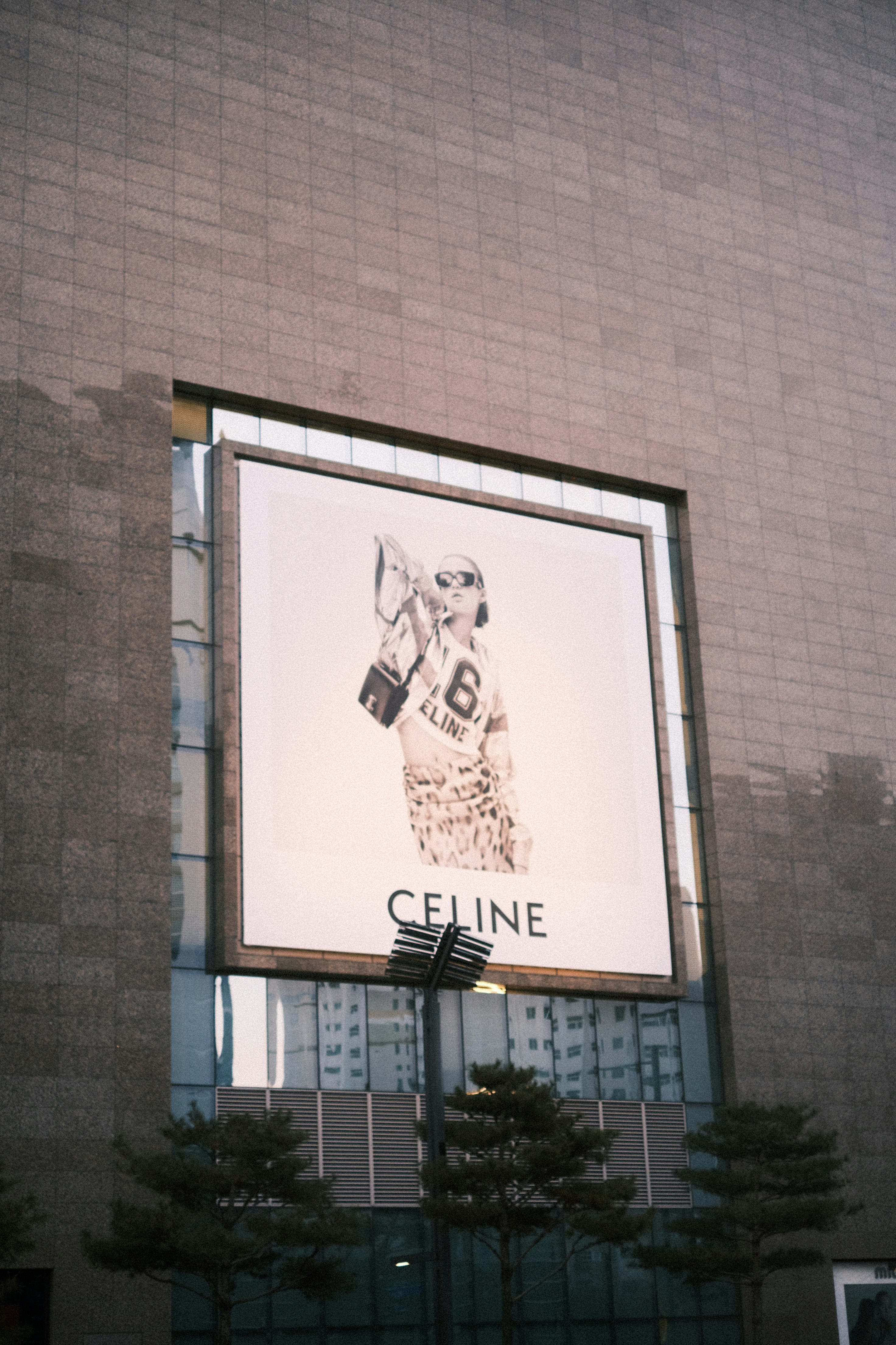 A large advertisement on the side of a building photo – Free Woman ...