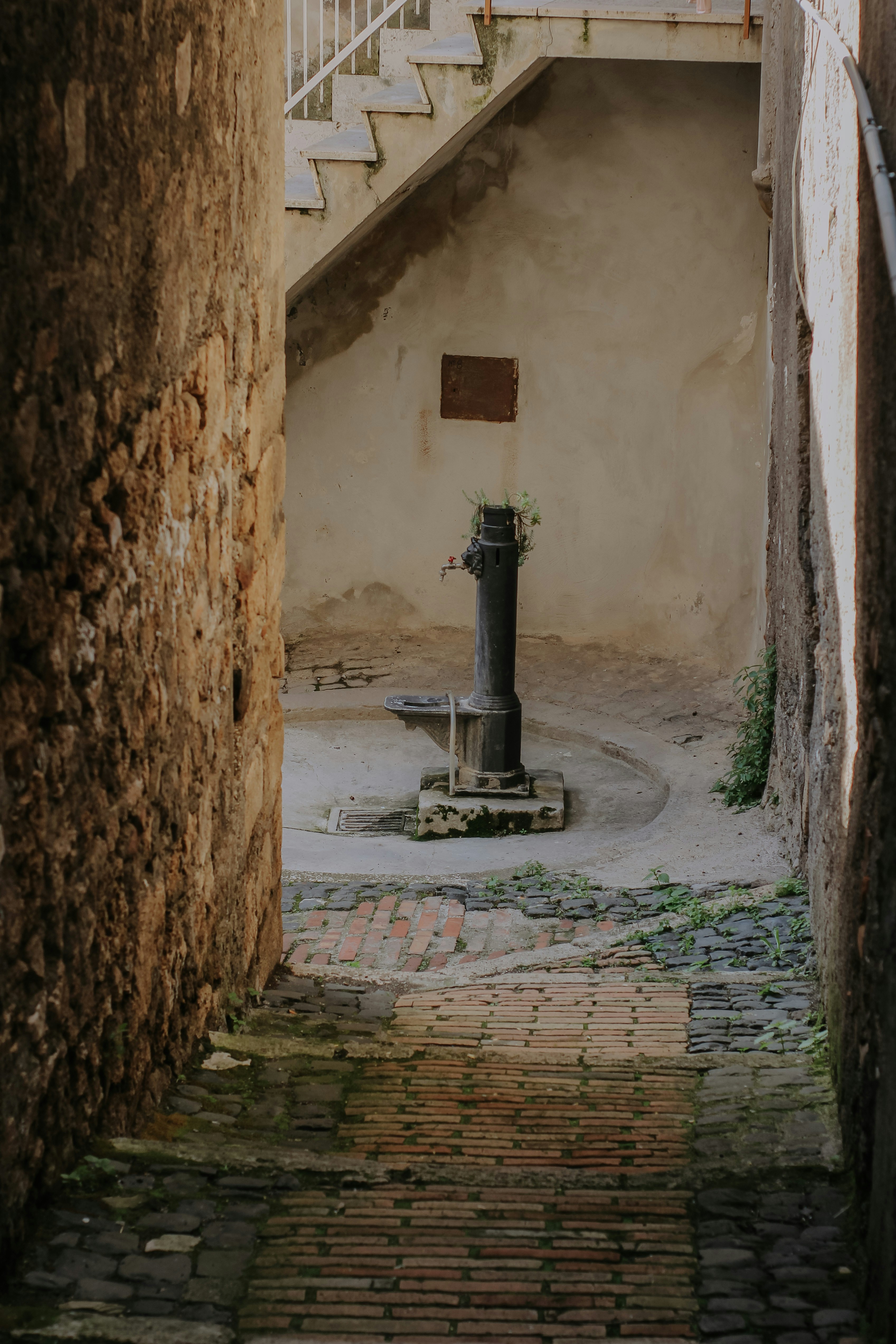 An alley way with a fire hydrant and stairs photo – Free Walkway Image ...
