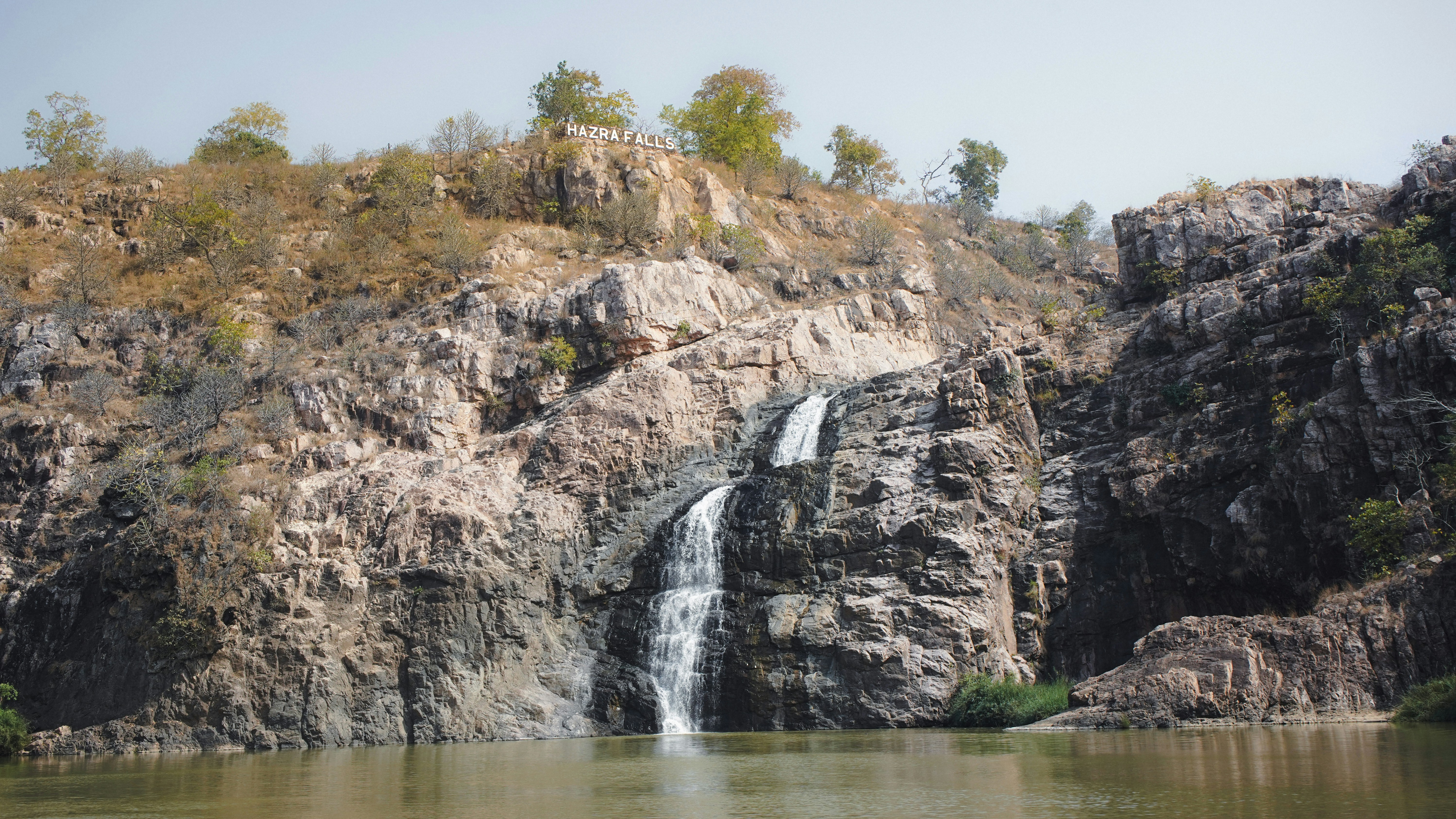 A large waterfall in the middle of a body of water photo – Free Hajra ...