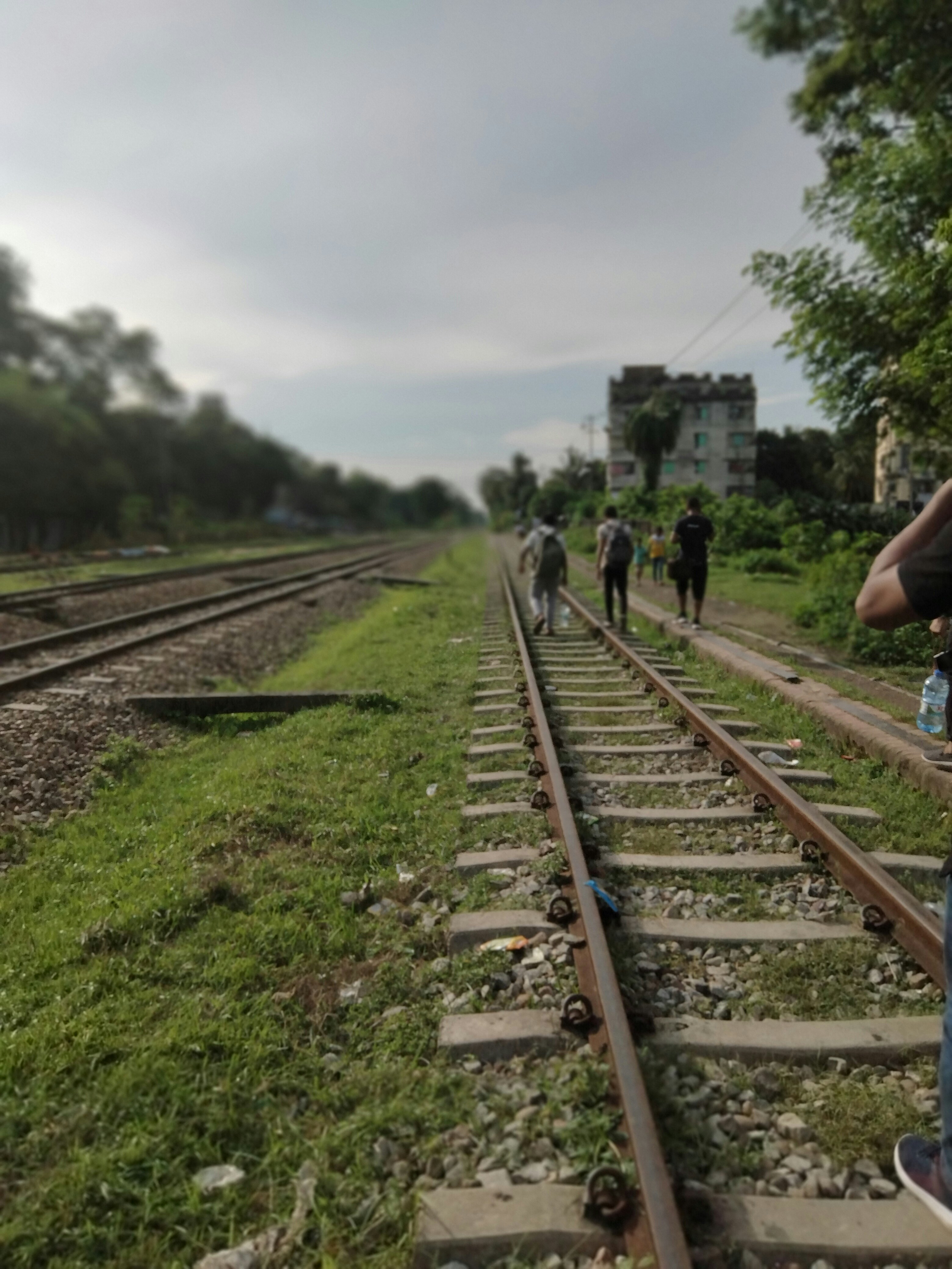A group of people walking down a train track photo – Free Chittagong ...