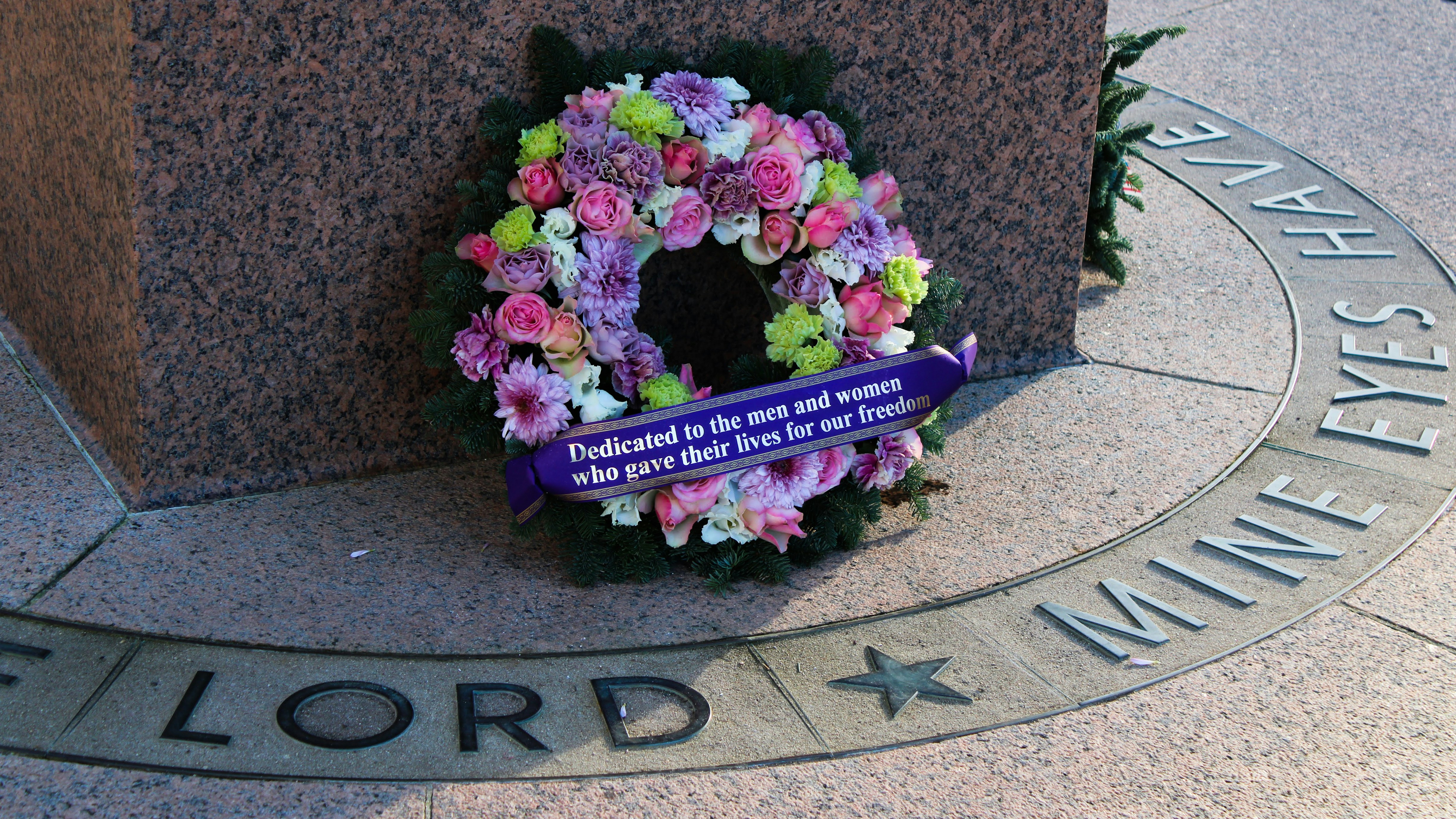 Pastel Wreath at the Monument's Base: A Quiet Circle of Remembrance