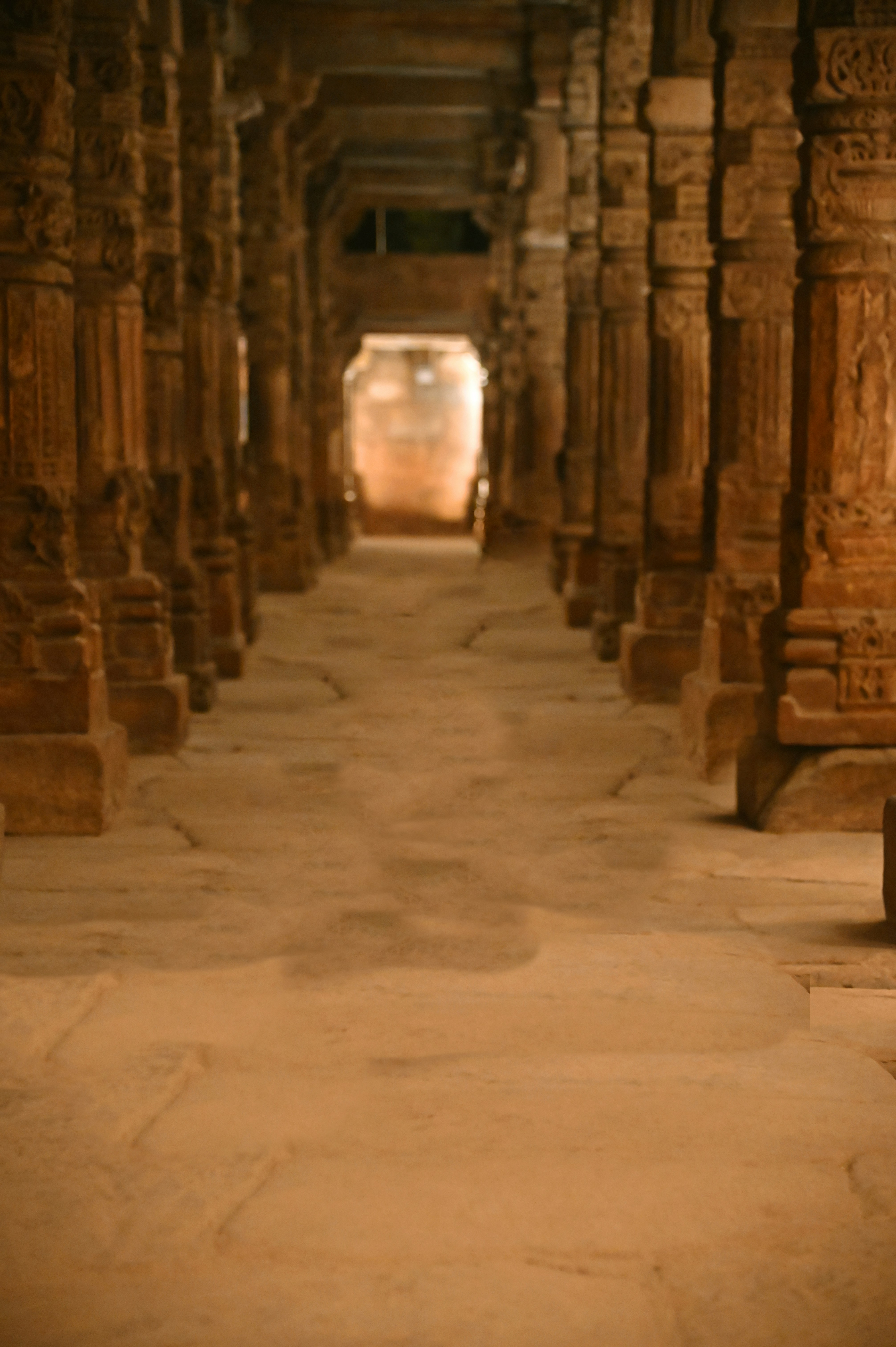 A long hallway with columns and a clock on the wall photo – Free Crypt ...